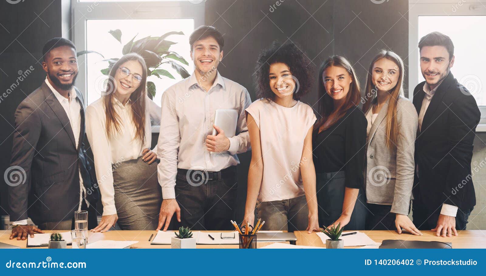 Successful Business Team Looking at Camera in Office Stock Photo ...