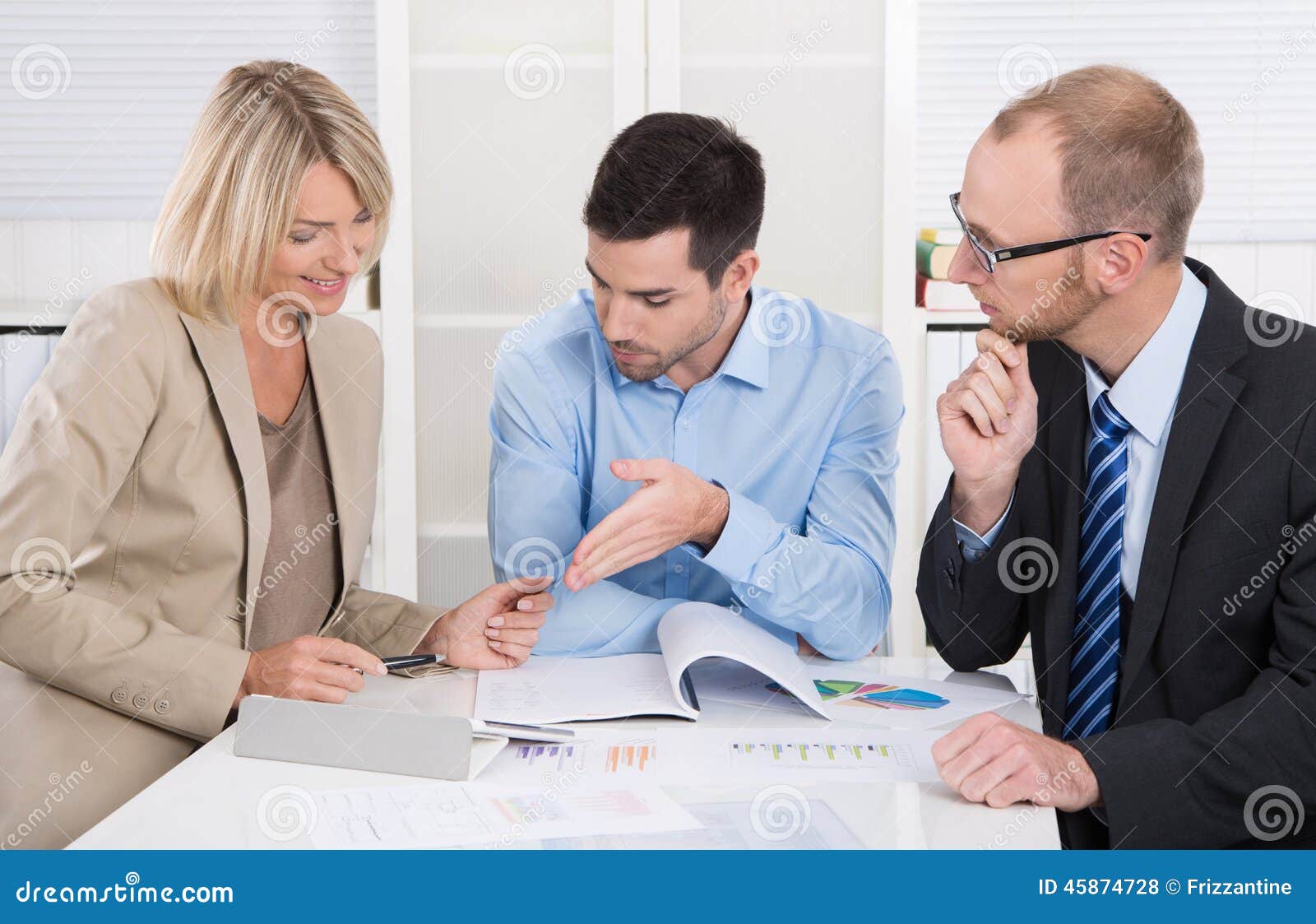 Successful Business Team Sitting Around a Table in a Meeting. Stock ...