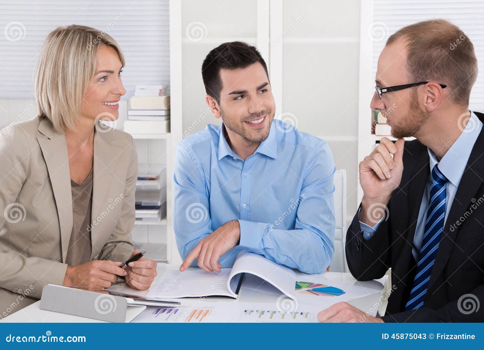 Successful Business Team Sitting Around a Table in a Meeting. Stock ...