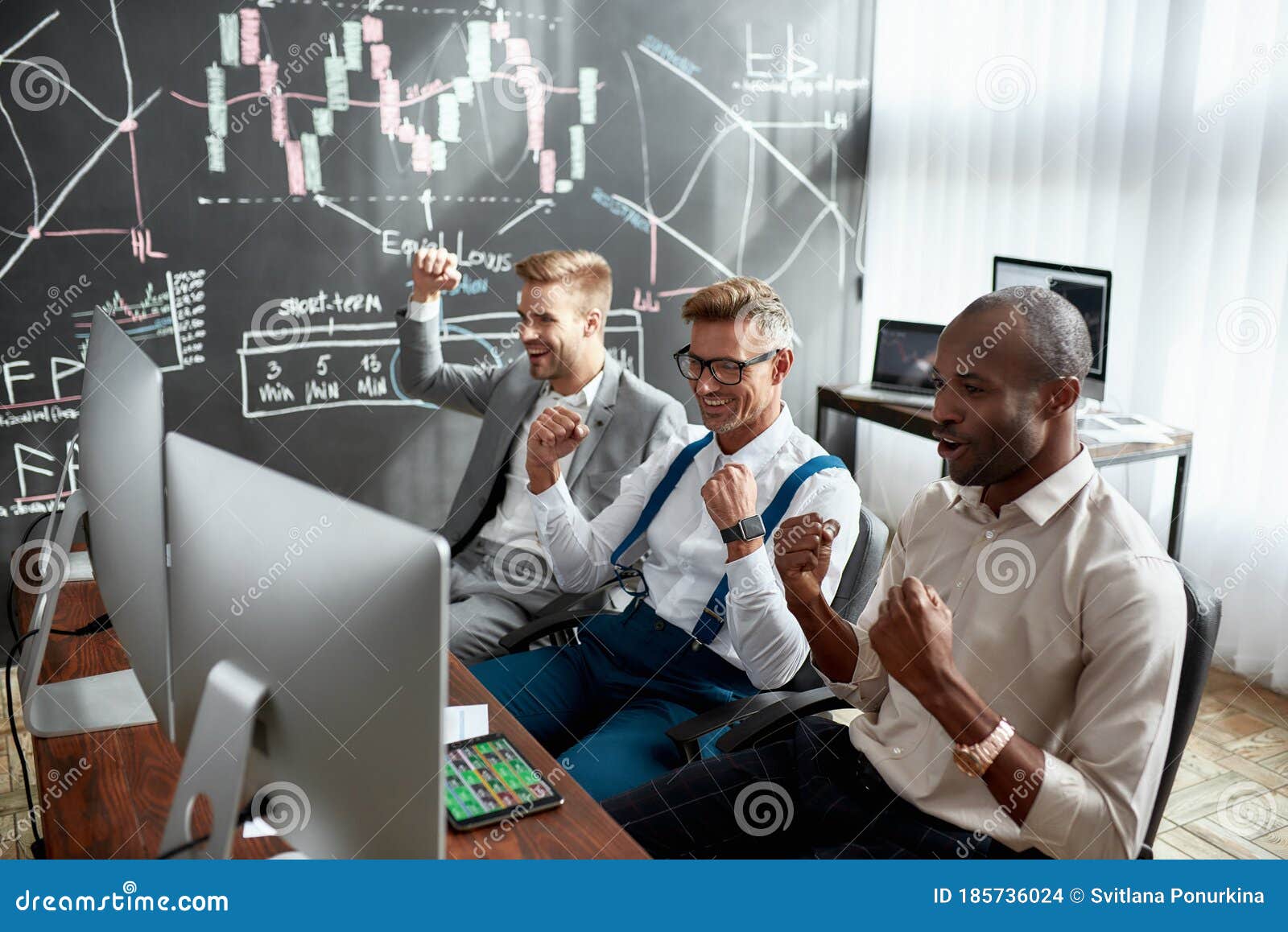 Successful Business Team. Three Stock Traders Looking at Graphs ...