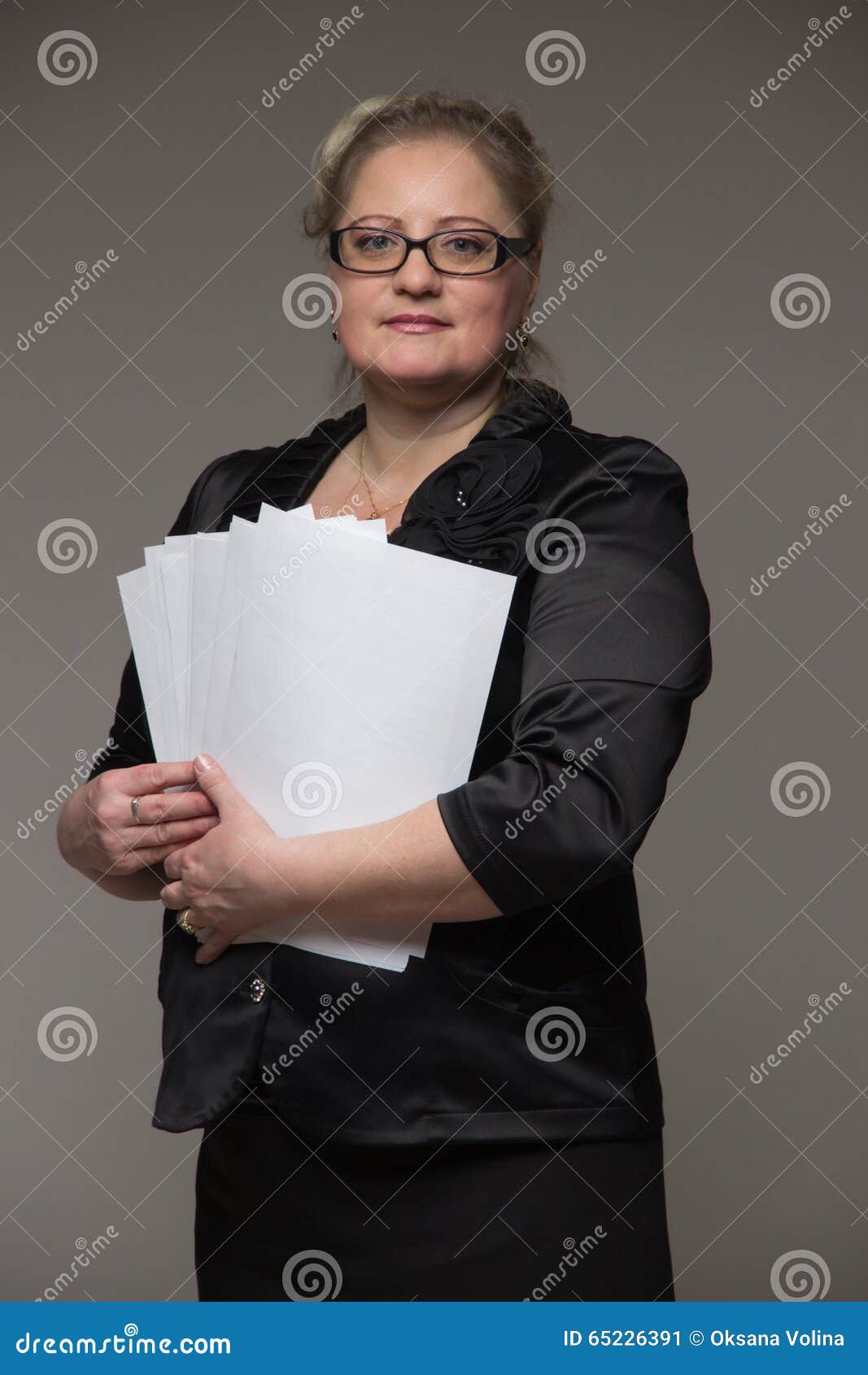Successful Business Woman is Not Young in a Suit with Papers and Stock ...