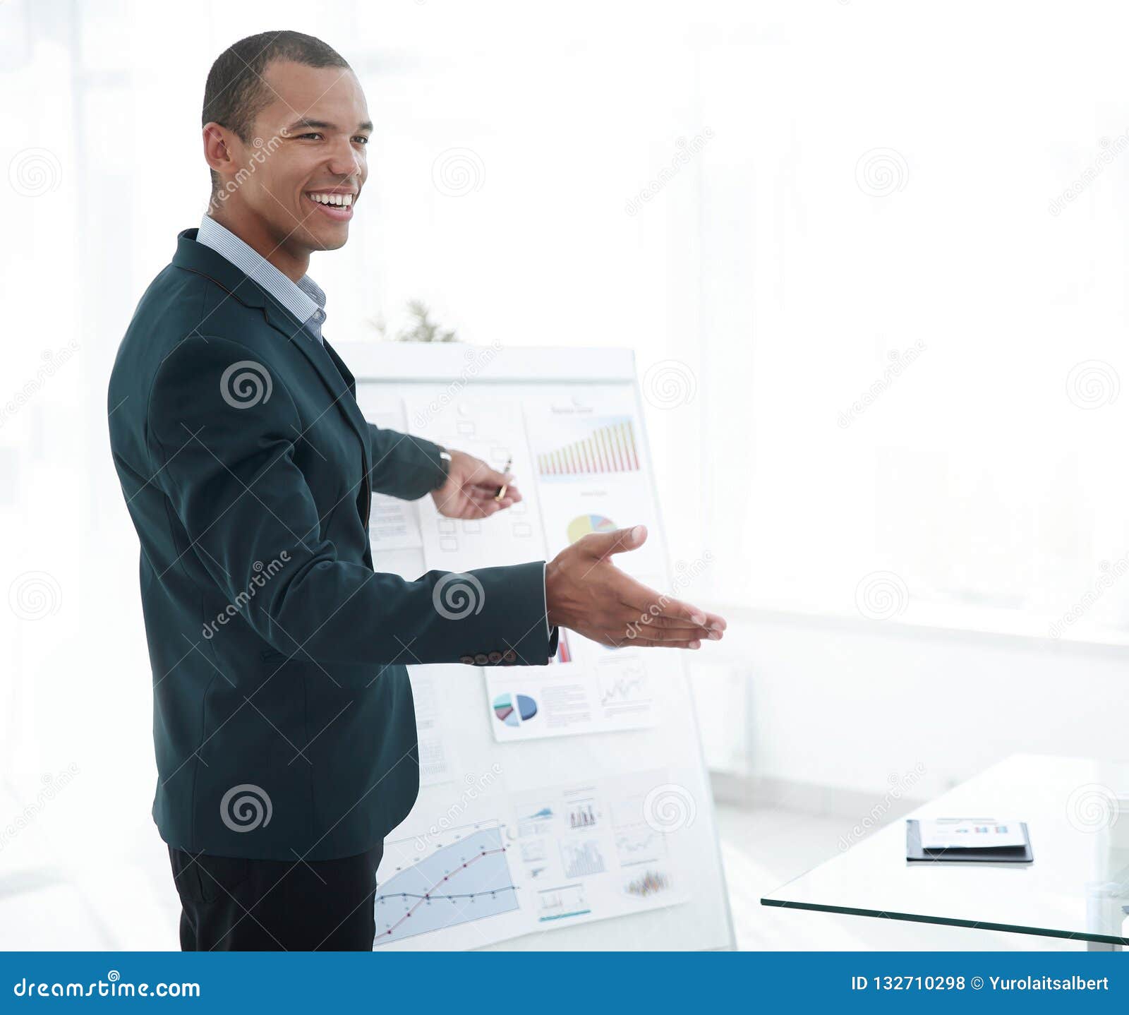Successful Businessman Pointing To a Flip Chart with the Financial ... Successful Businessman Pointing To a Flip Chart with the Financial ...