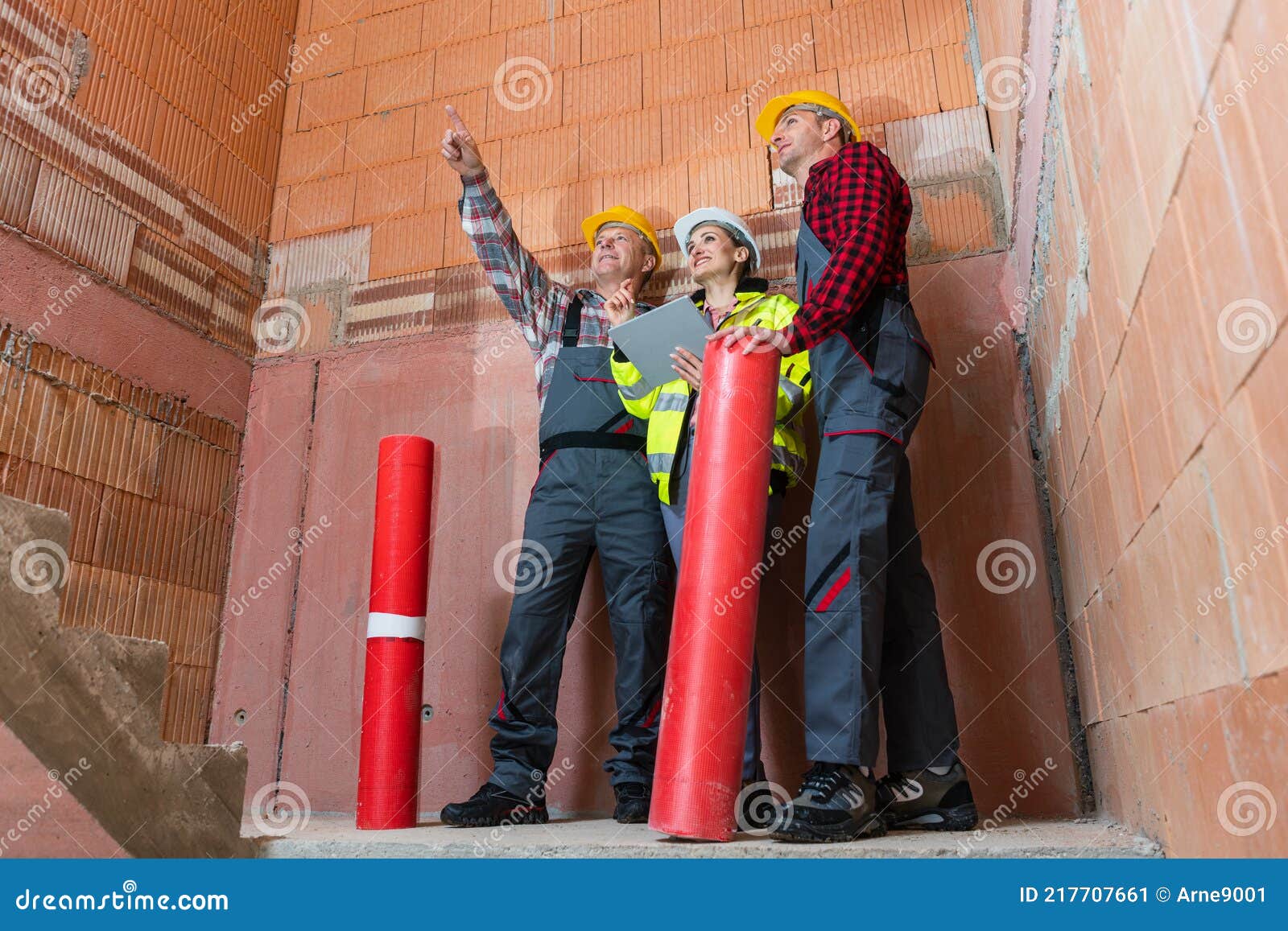 Male Construction Workers Discussing Project of Building Stock Image ...