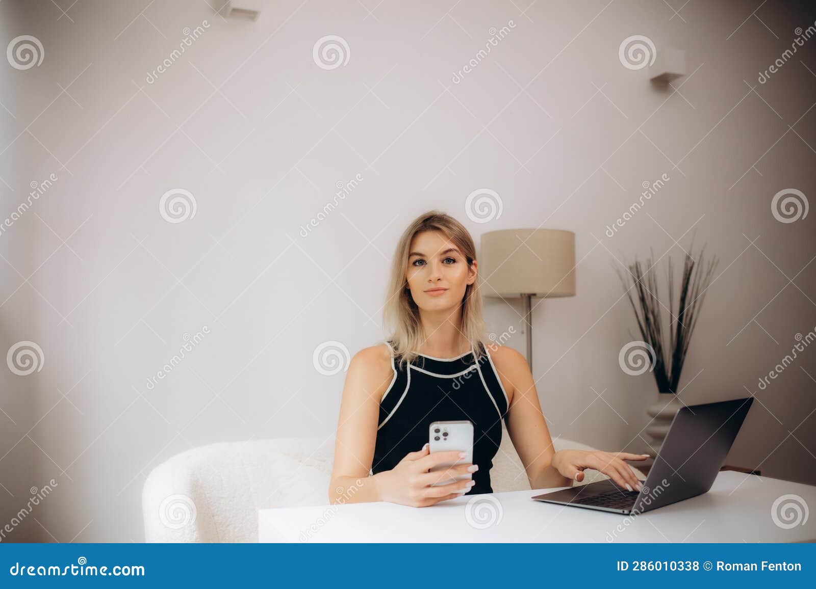 Successful Female Grapic Designer Watching Tutorial about Creative Ideas at Laptop Computer ...