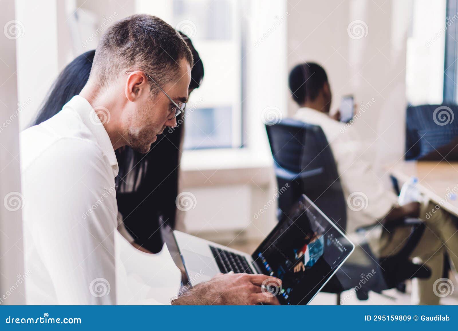 Successful Male Employee Using Laptop while Standing in Office Stock ...