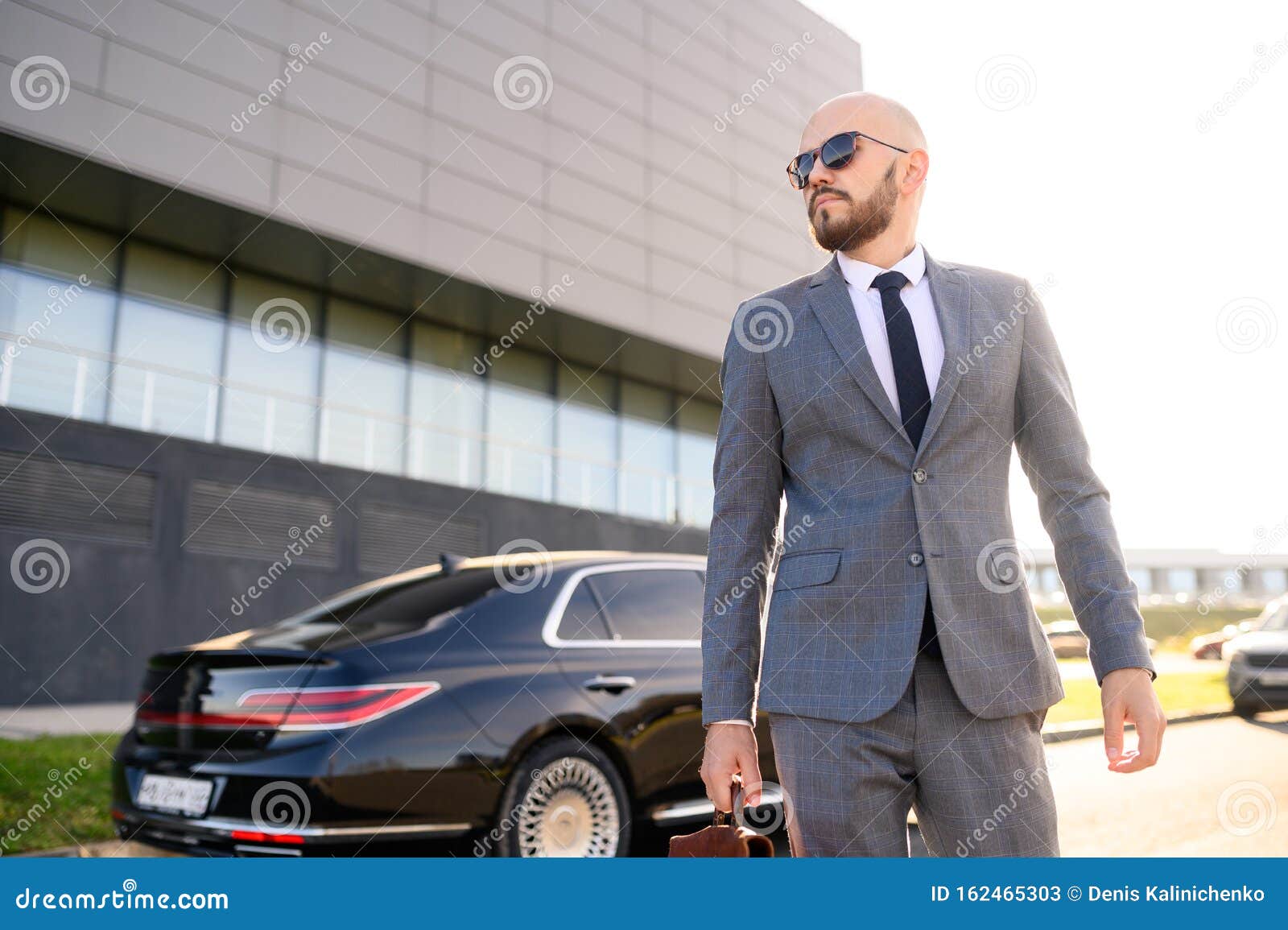 Successful Man in a Suit with a Briefcase on the Background of an ...
