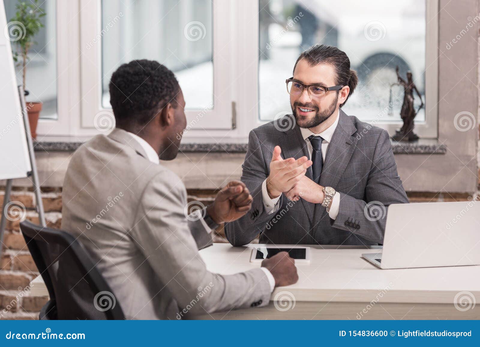 Successful Multicultural Businessmen Sitting at Table and Having ...