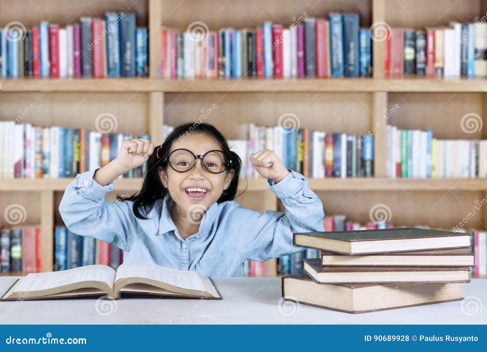Student Lifting Hands With Books And Doodle In Classroom Royalty-Free ...