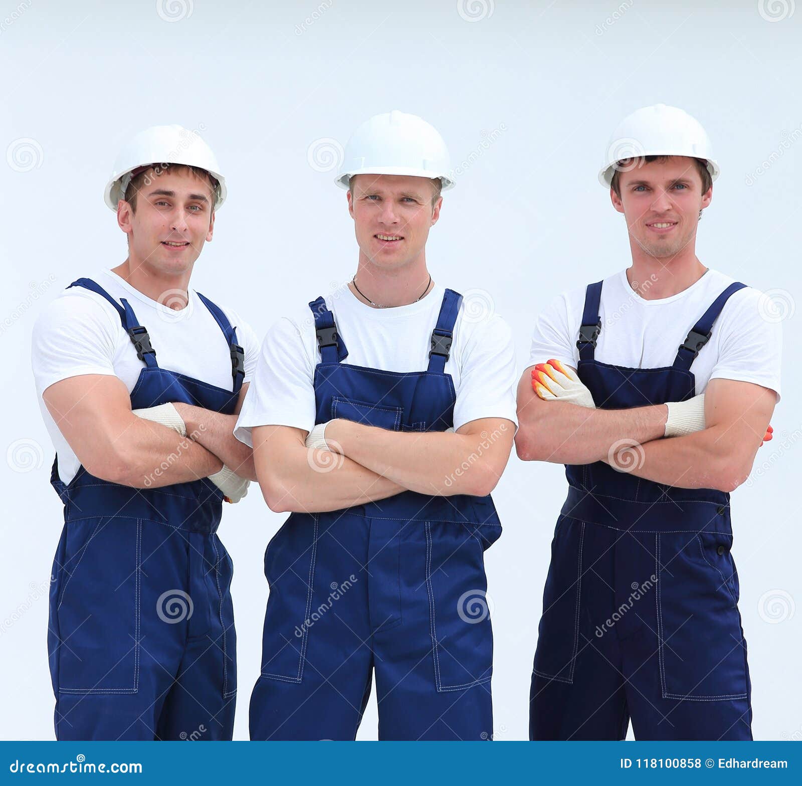 Team Of Builders Engineers At Construction Site, Reading Blueprint ...