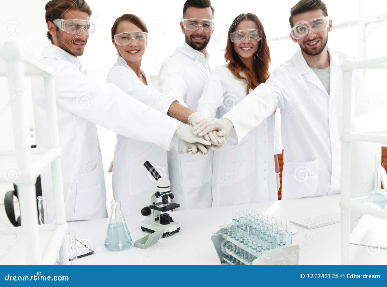Successful Team of Young Scientists with Hands Clasped Together. Stock ...