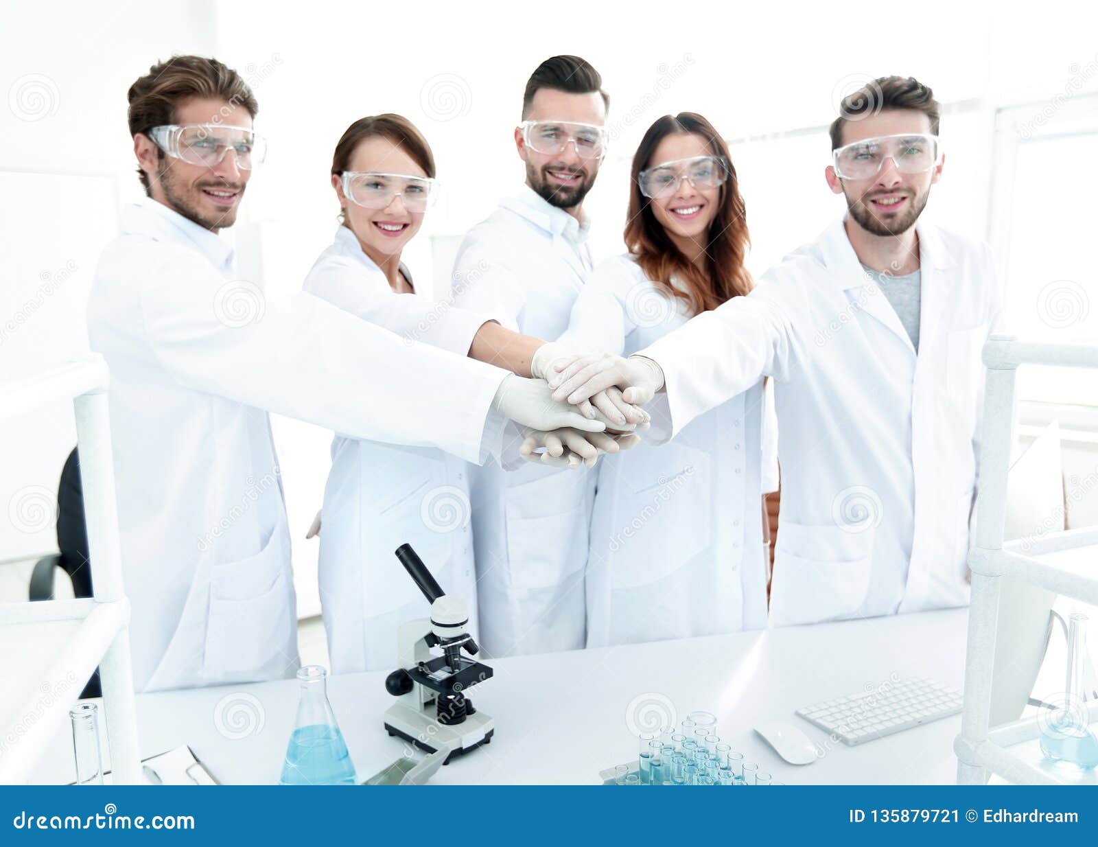 Successful Team of Young Scientists with Hands Clasped Together. Stock ...