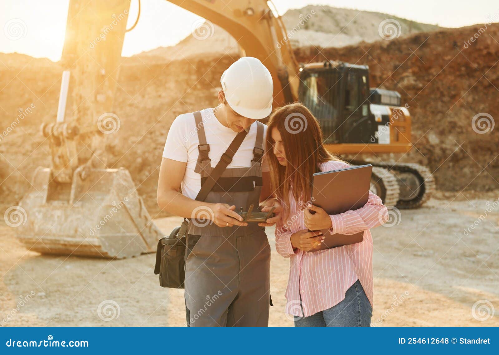 Successful Teamwork. Two People is on the Borrow Pit at Daytime ...