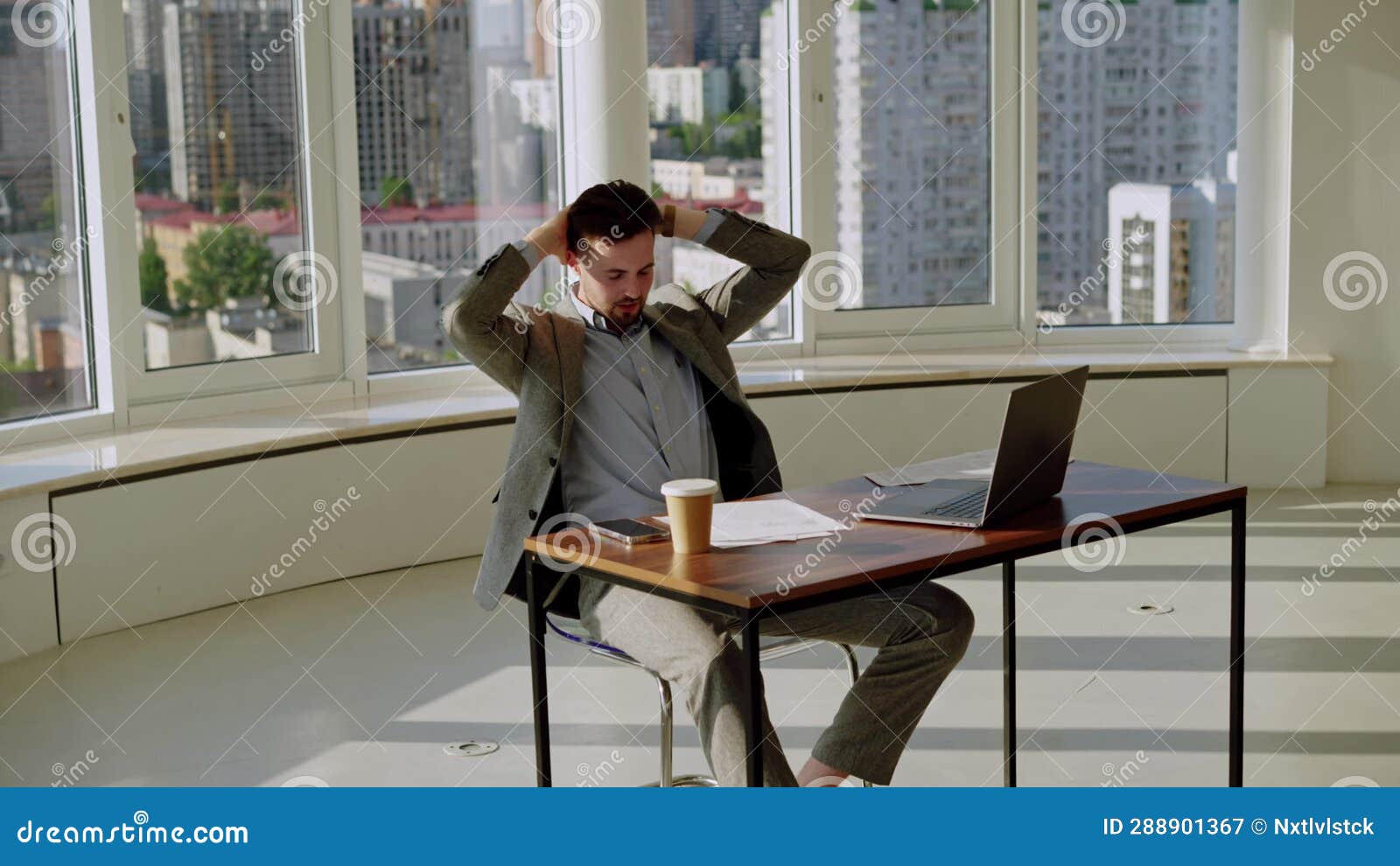 A Successful Young Businessman in a Nice Suit in the Office Near the ...