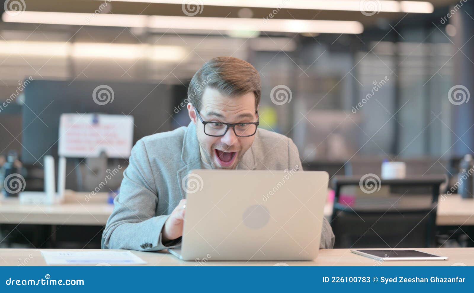 Successful Young Man Celebrating on Laptop in Office Stock Image ...