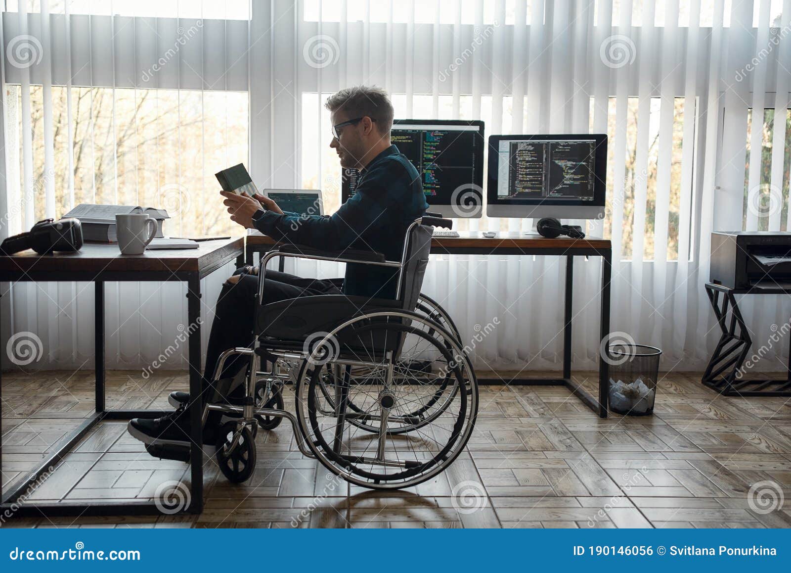 Such an Interesting Book. Side View of Young Male Web Developer in a Wheelchair Holding a Book ...