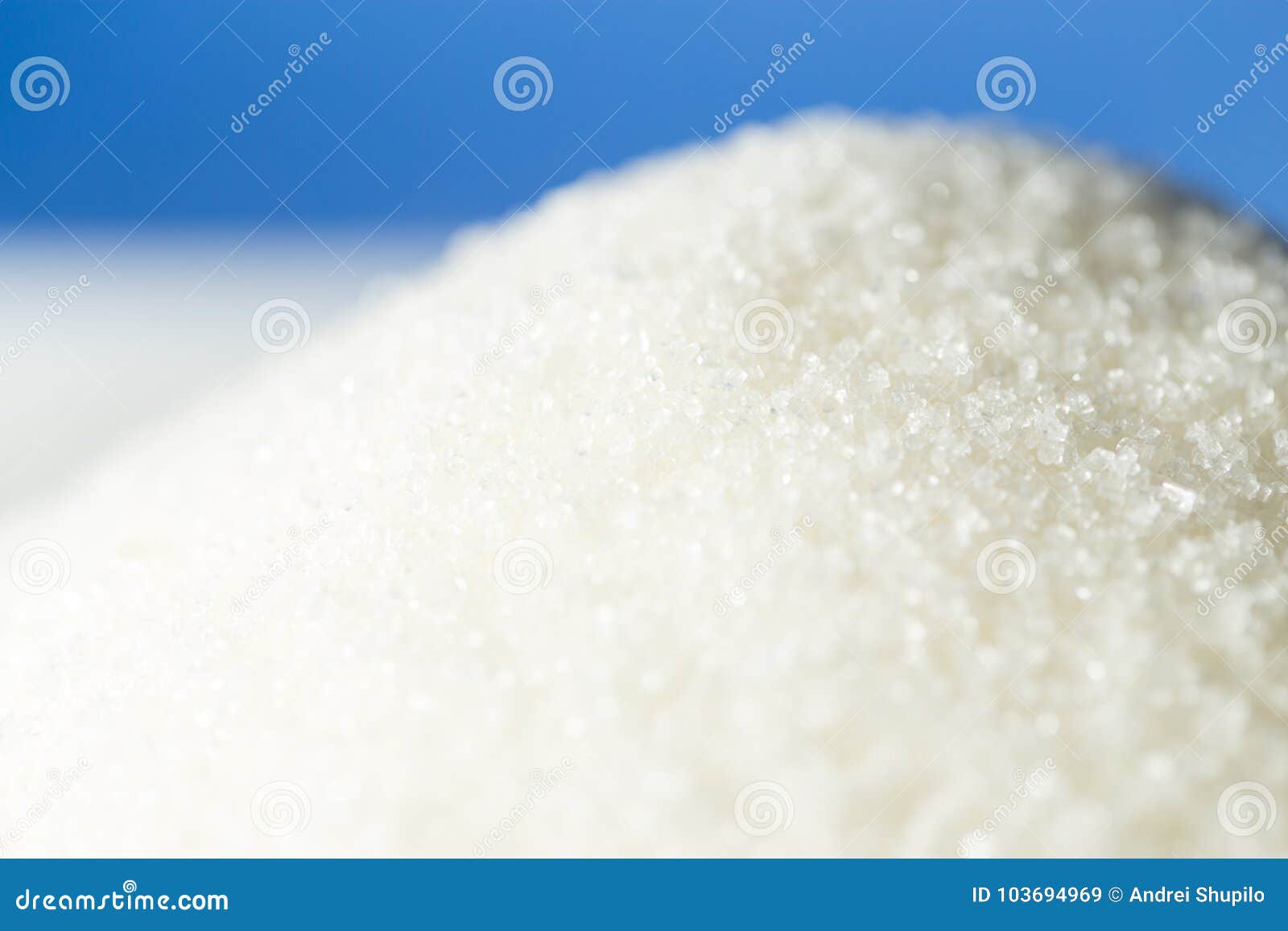 Sugar on a blue background stock image. Image of dune - 103694969
