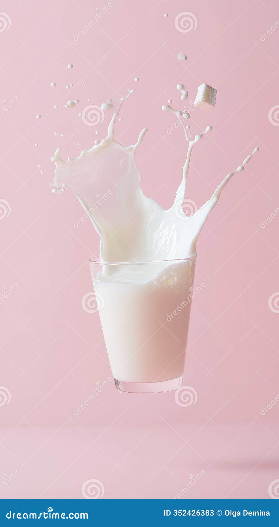 Sugar Cube Falling into Levitating Glass of Milk Splashing on Pink ...