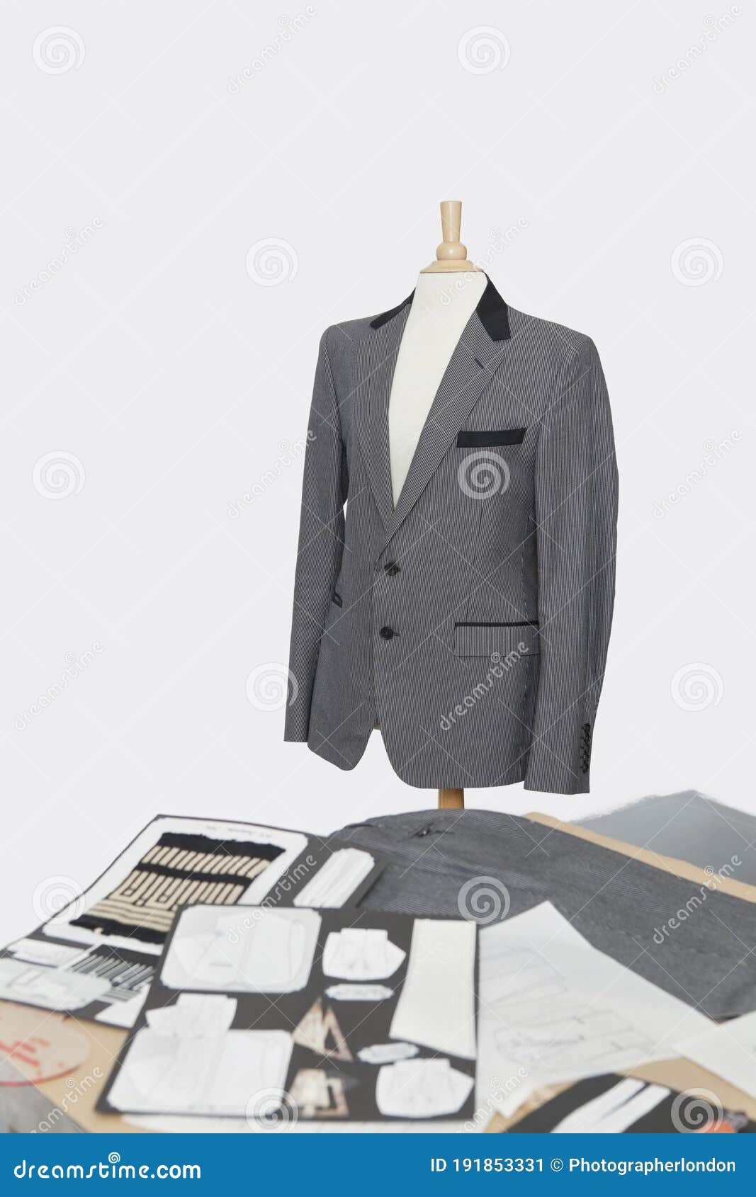 Suit On Tailor`s Dummy With Design Layouts Over Gray Background Stock ...