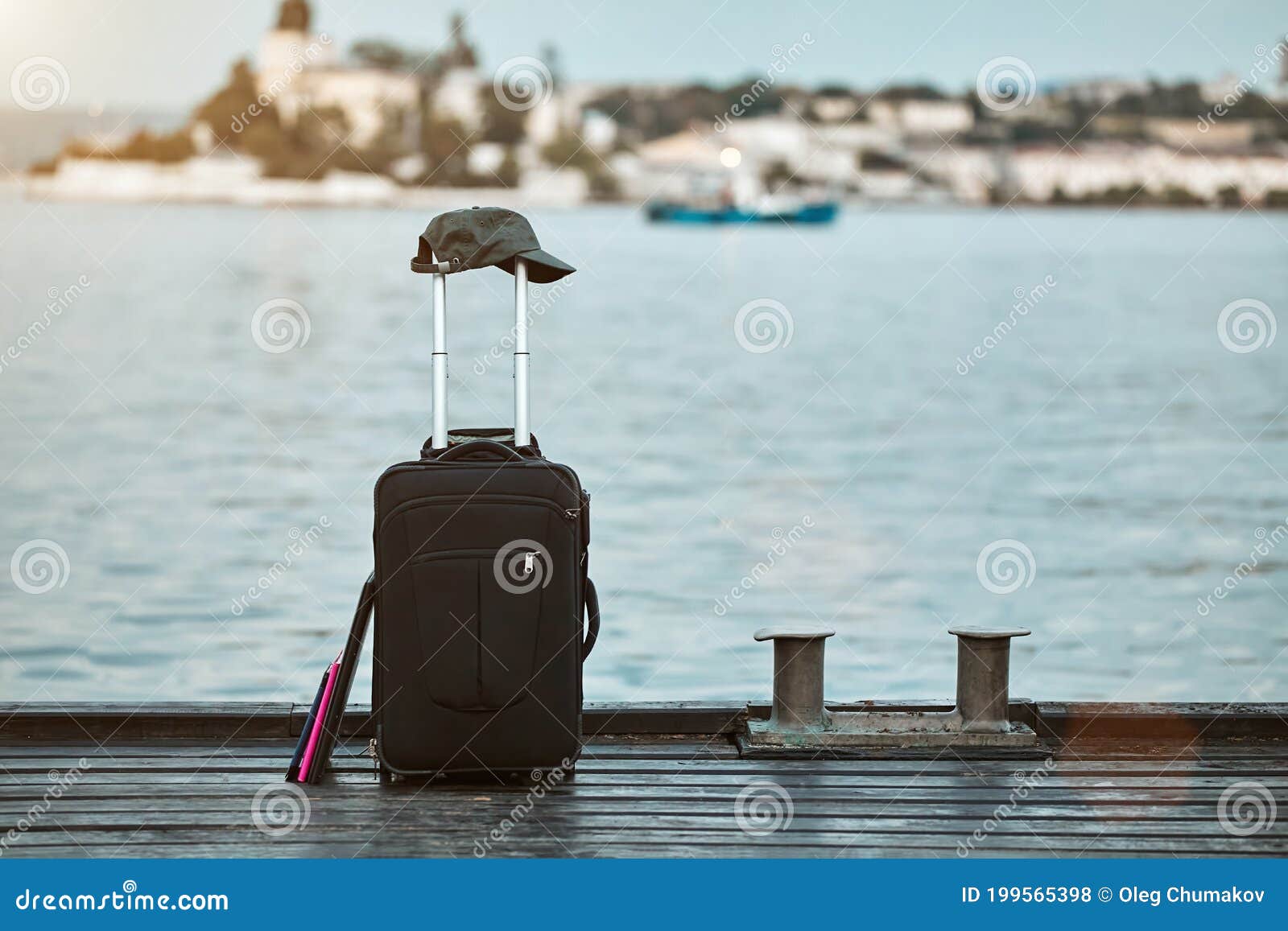Suitcase with Cap on Top Standing on Pier. Modern Computer and Folder ...