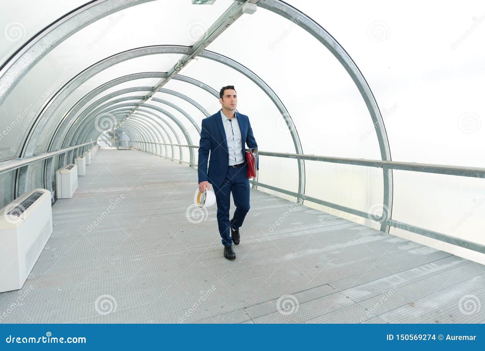 Suited Man Walking Along Arched Walkway Stock Photo - Image of arched ...