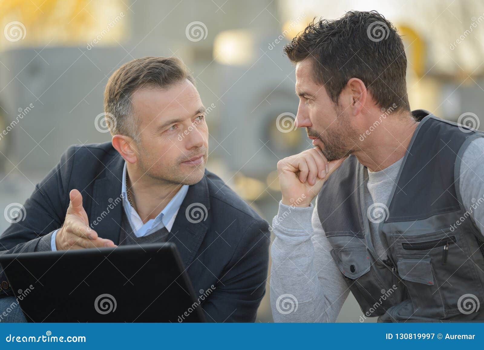 Suited Man and Workman Looking at Laptop Outdoors Stock Image - Image ...