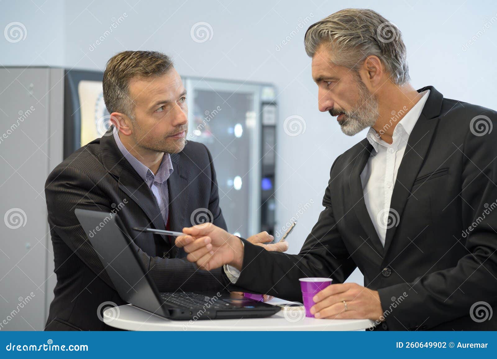 Suited Men Looking at Laptop during Coffee Break Stock Photo - Image of ...