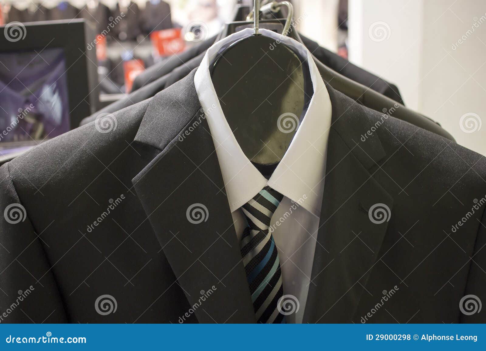 Suits and shirts on a rack stock photo. Image of store - 29000298