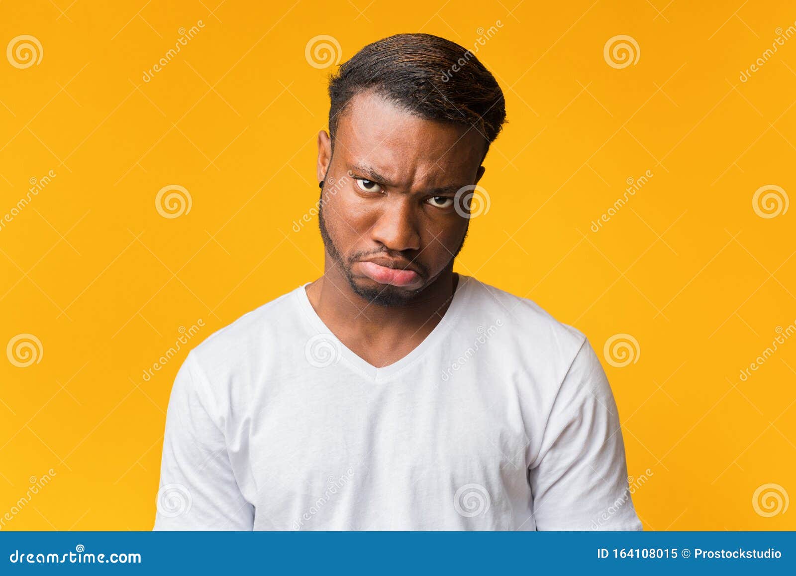 Sulky Afro Guy Looking at Camera Posing Over Yellow Background Stock ...