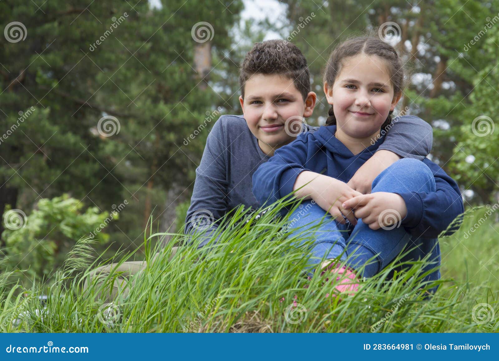 In Summer, a Brother and Sister Sit on the Grass in the Forest Stock ...