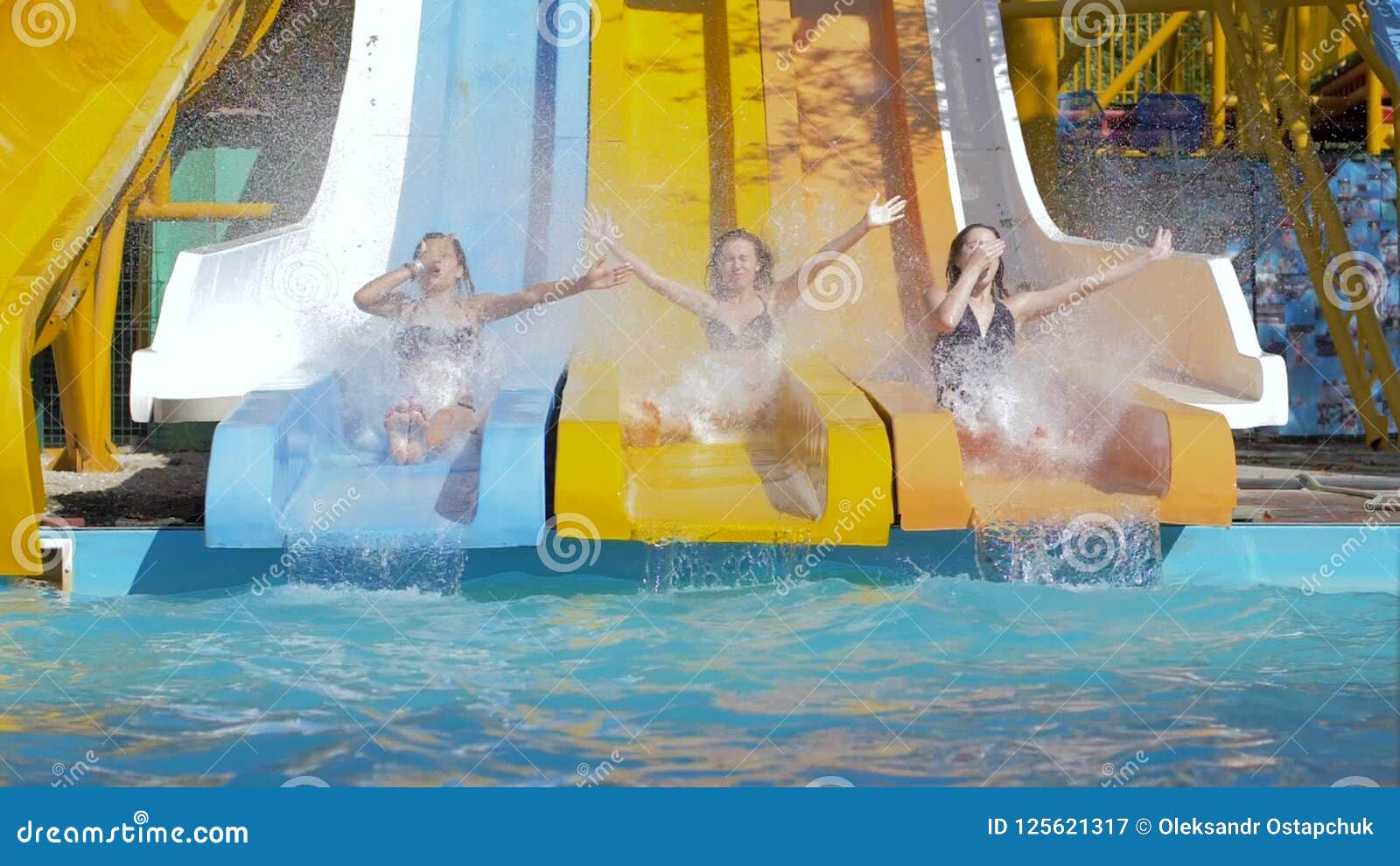 Summer Fun At Water Park Brave Girls Sliding Down On Waterslides And