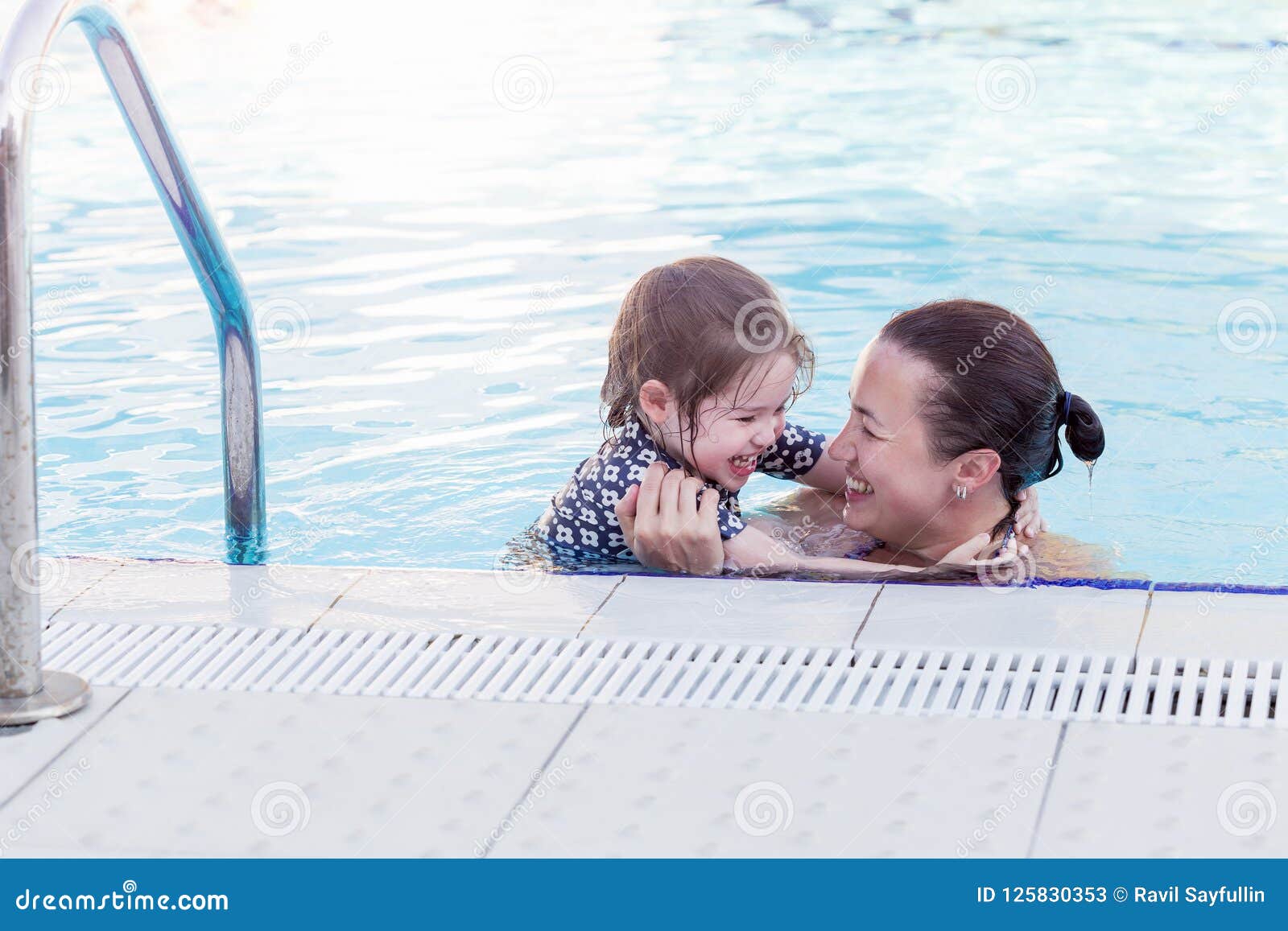 Happy Mother And Her Daughter Playing In Swimming Pool Stock Image