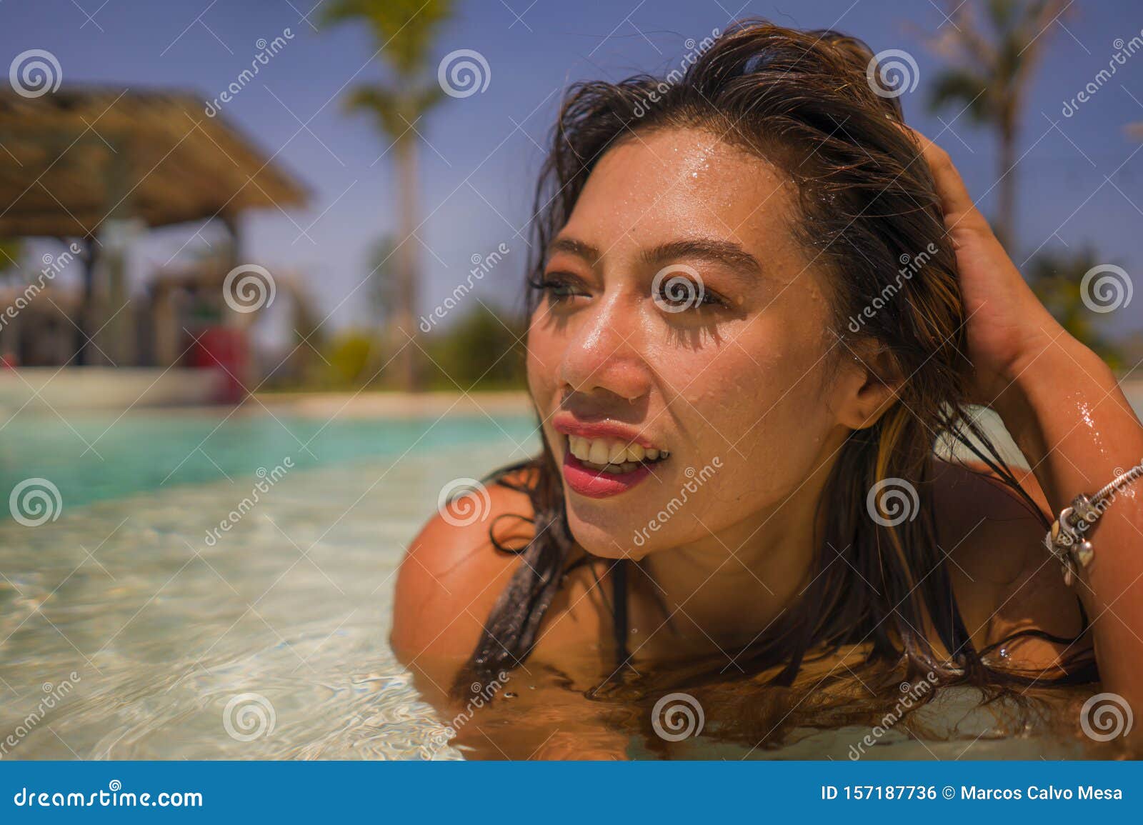 Young Beautiful And Happy Asian Indonesian Woman In Bikini Swimming In