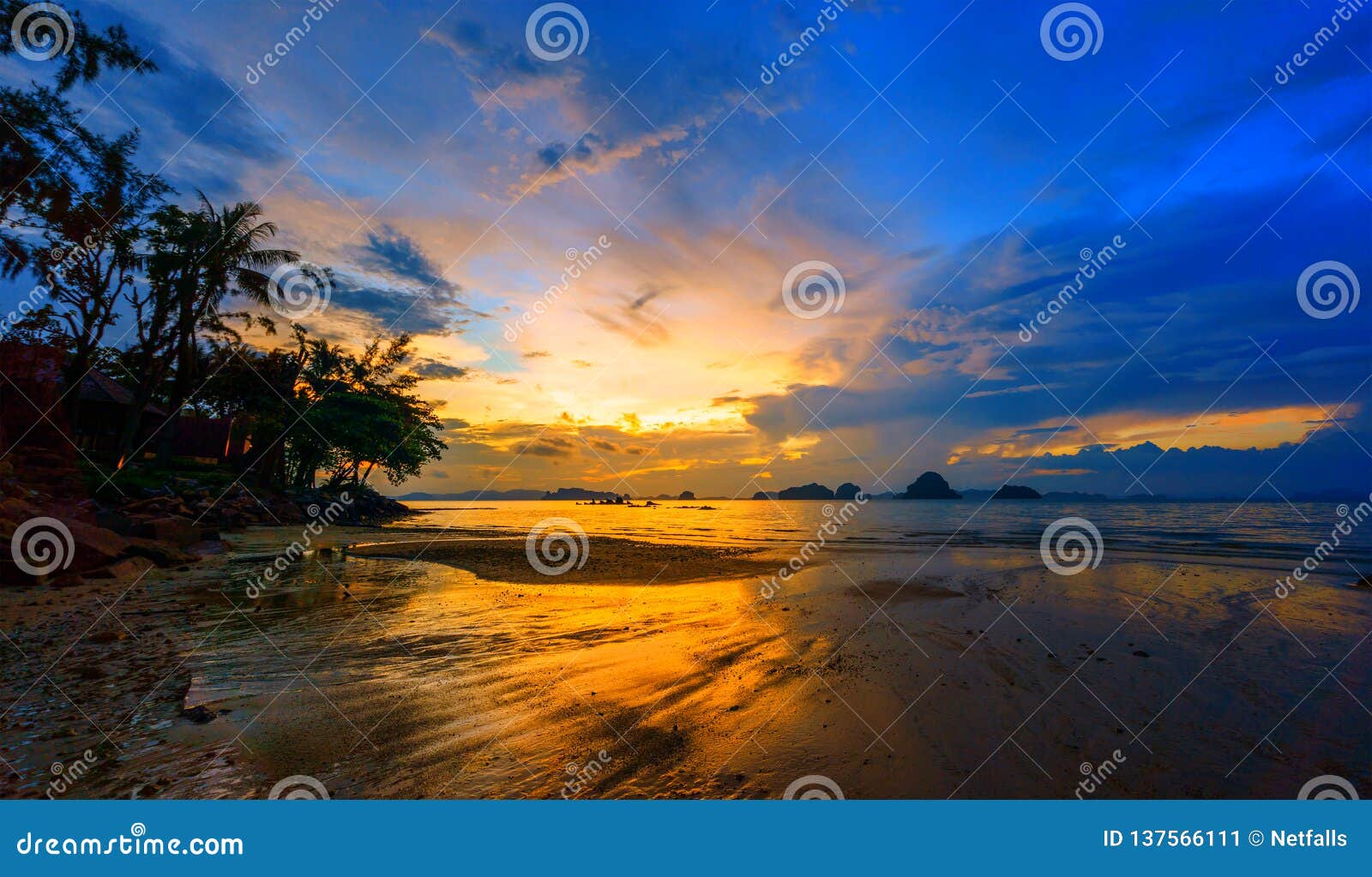 Tropical beach at sunset stock image. Image of coast - 137566111