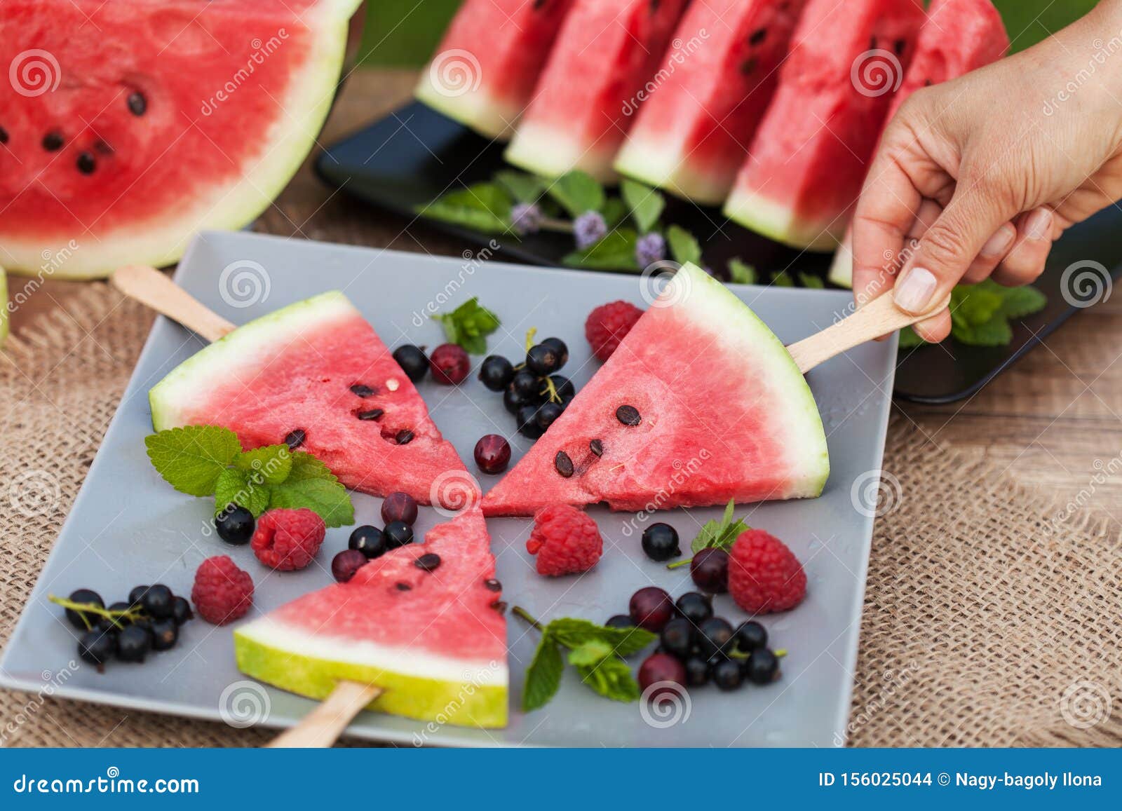 Summer Refreshing Snack Concept with Hand Taking Watermelon Slice from ...