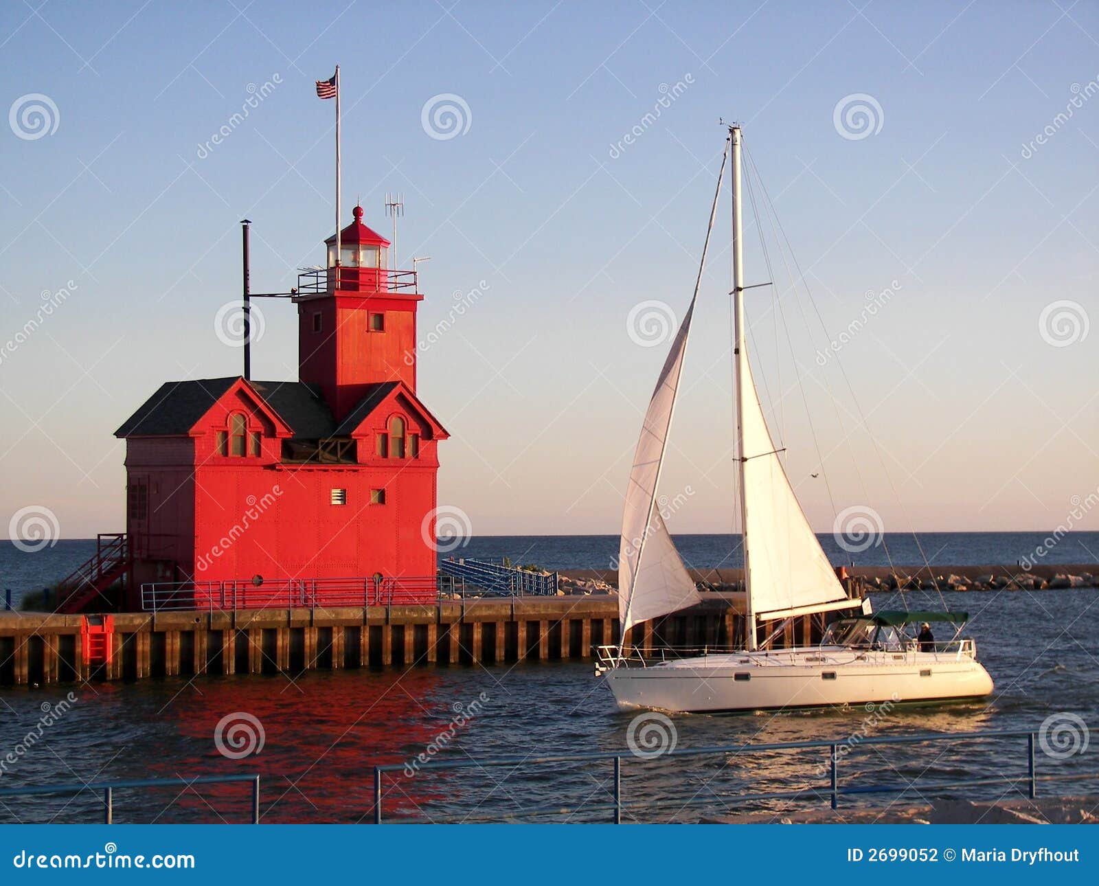 Michigan Red Lighthouse with Sailboat Stock Photo - Image of light ...