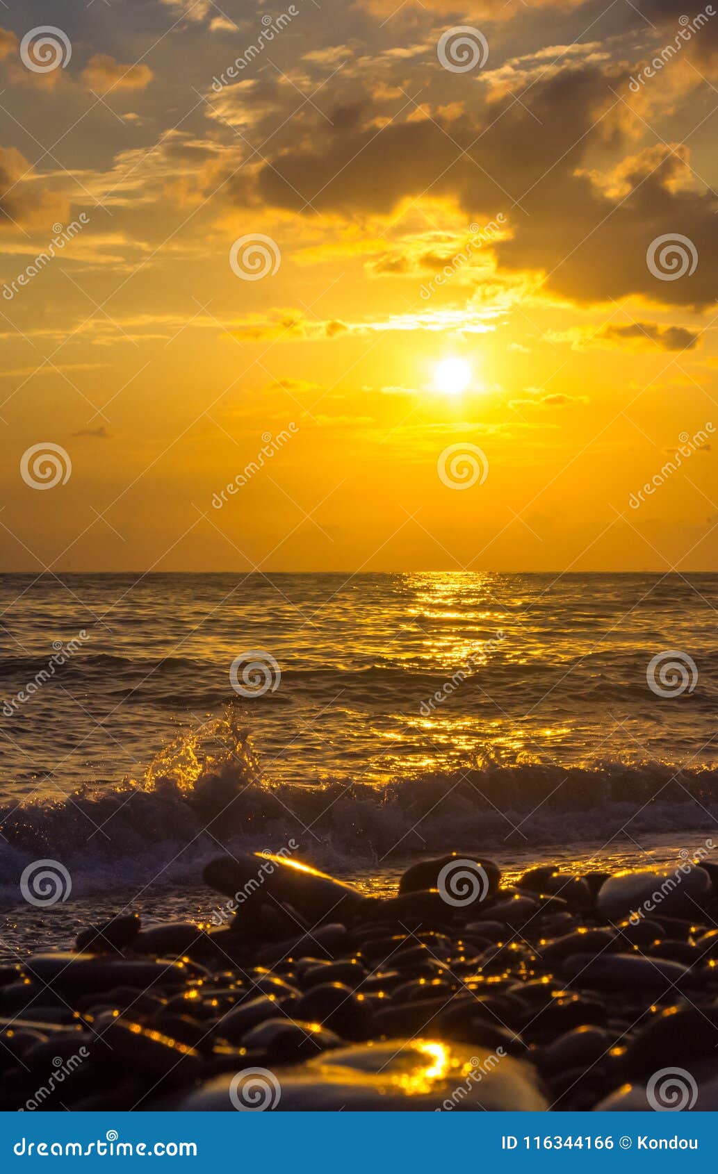 Amazing Sea Sunset on the Pebble Beach, the Sun, Waves, Clouds Stock ...