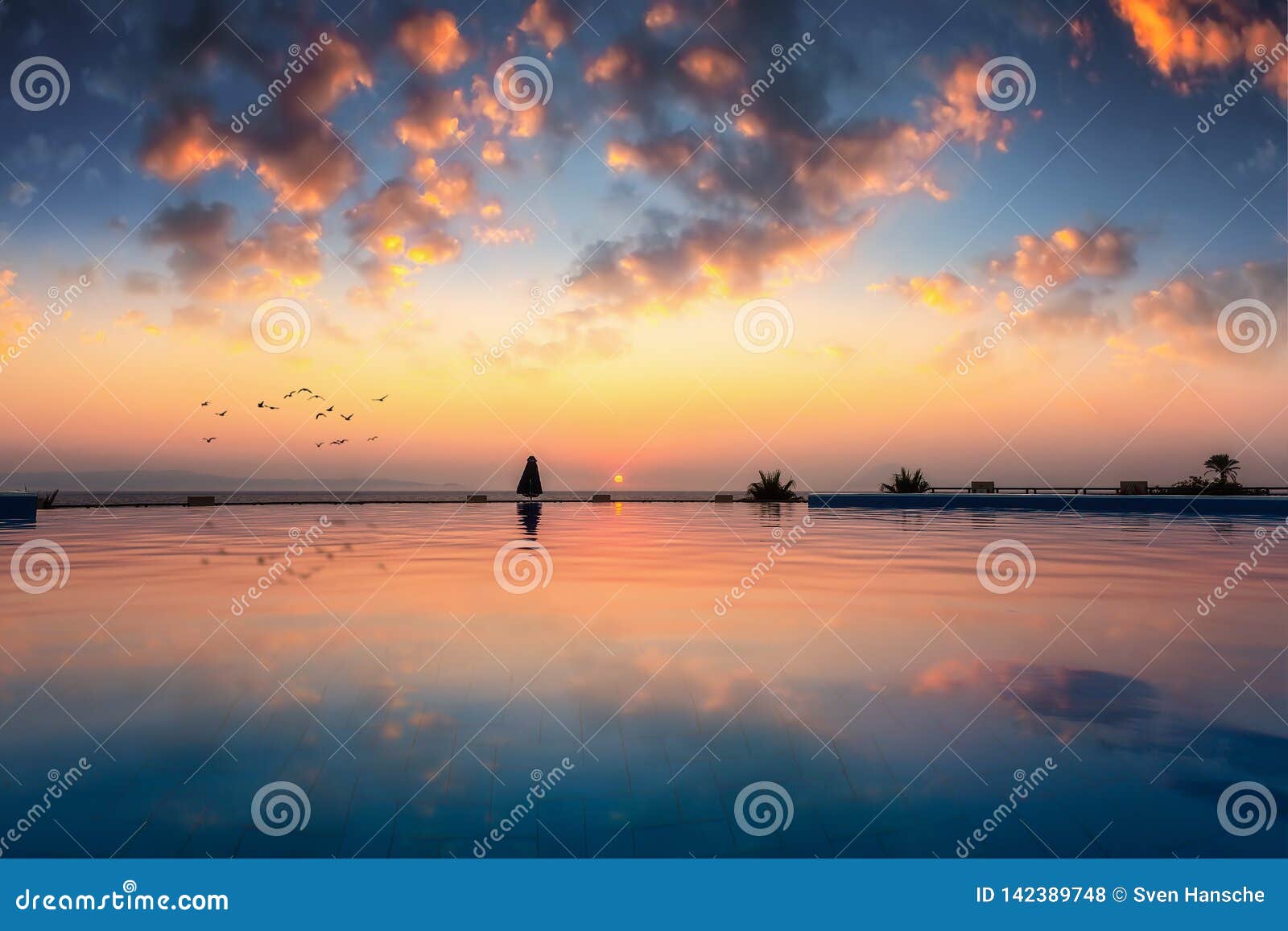 Summer Sunset Reflections in the Water of an Infinity Swimming Pool ...