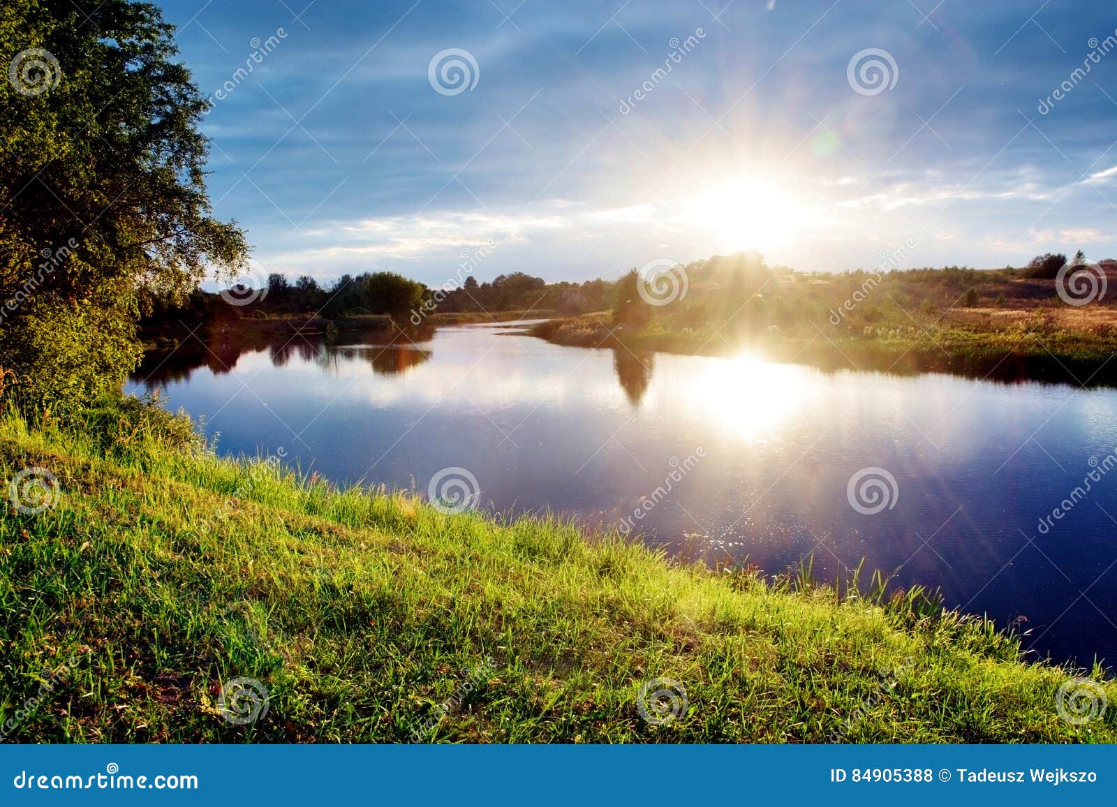 Summer View of Sunrise by the River with Sunbeams Stock Photo - Image ...