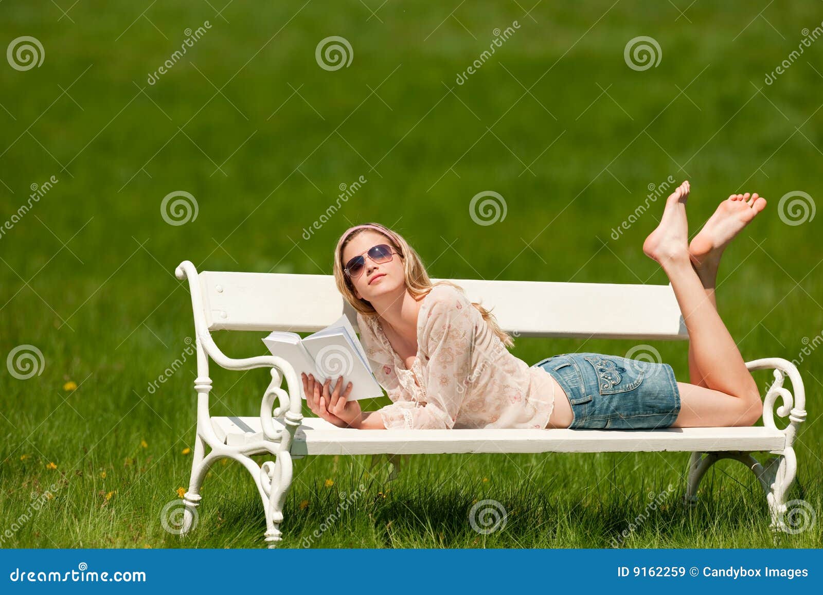 Summer - Young Woman Lying on Bench in Meadow Stock Image - Image of ...