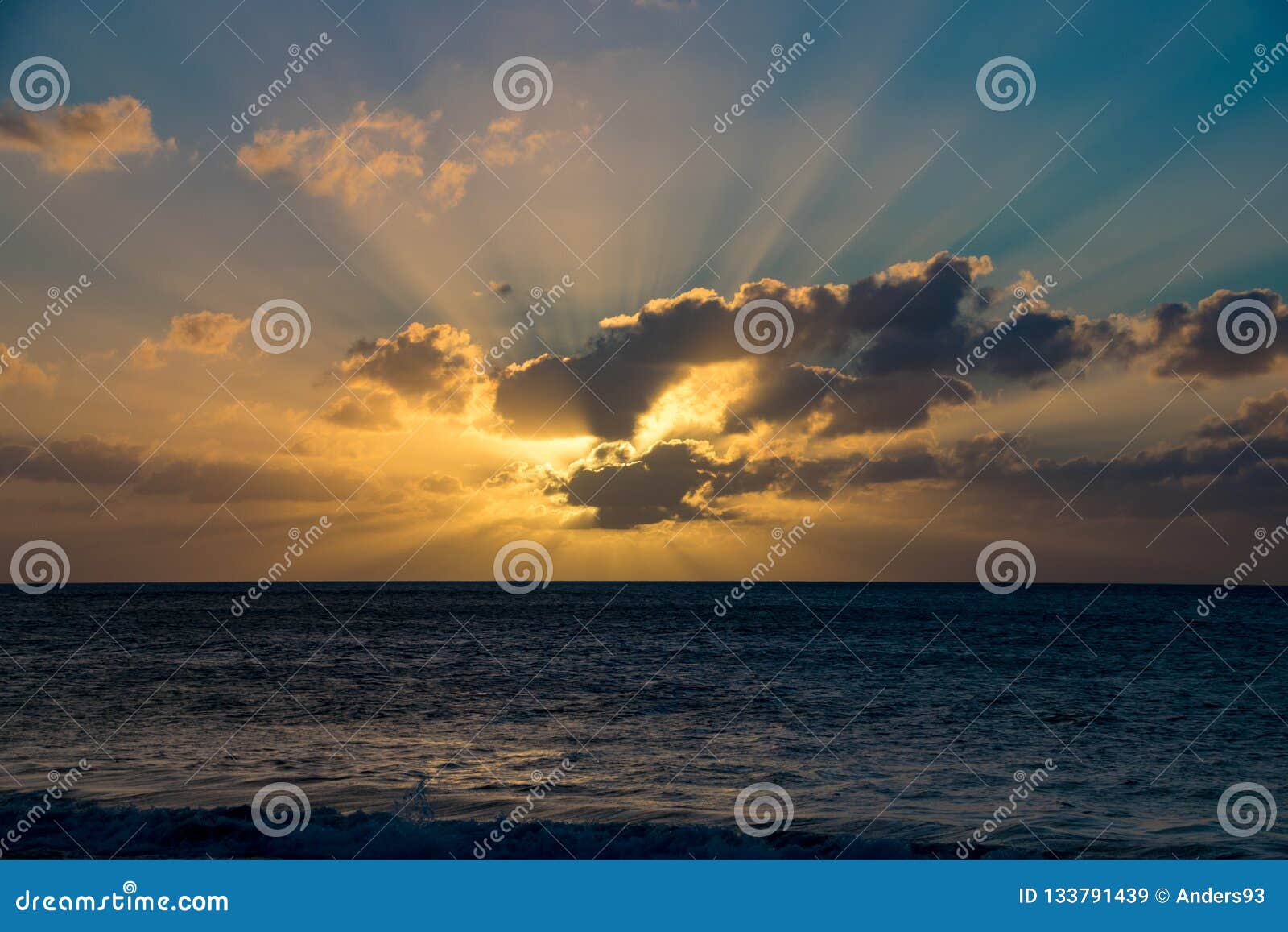 Setting Sun Reflecting Over a Calm Still Ocean Stock Image - Image of ...