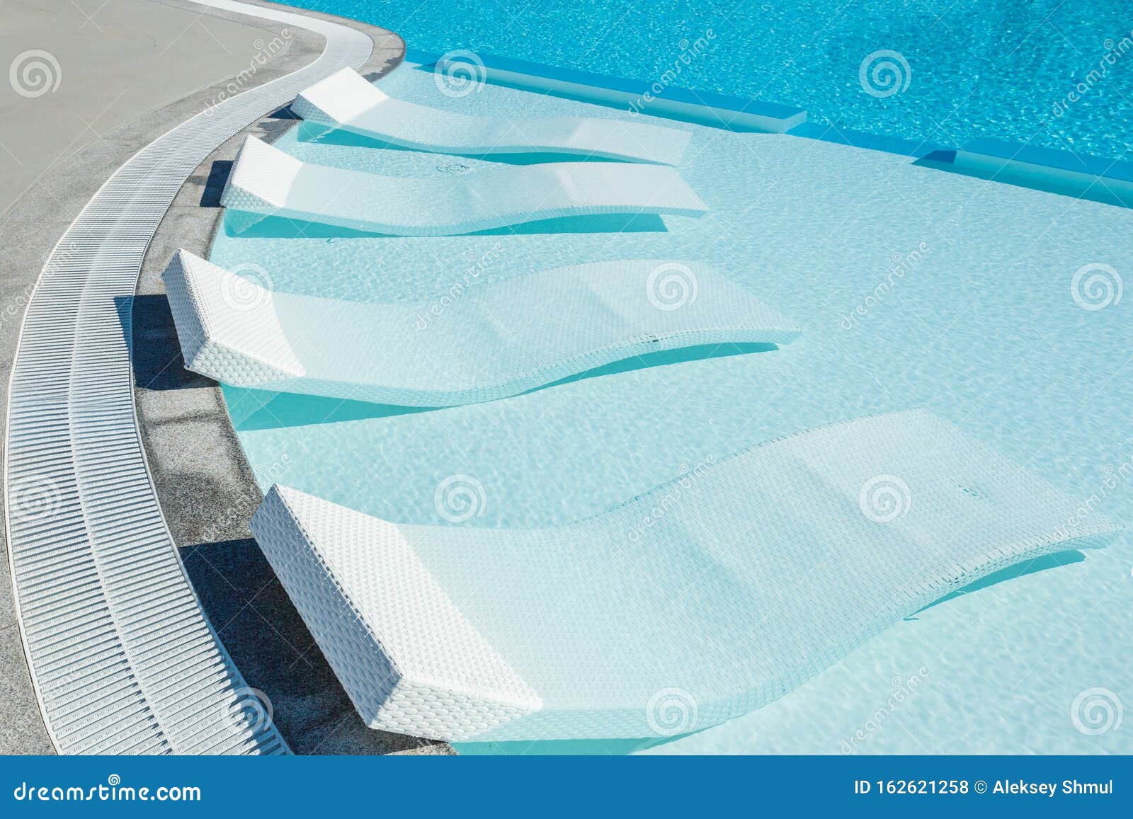 Sun Beds. Sun Beds in the Water. Swimming Pool Stock Photo - Image of ...