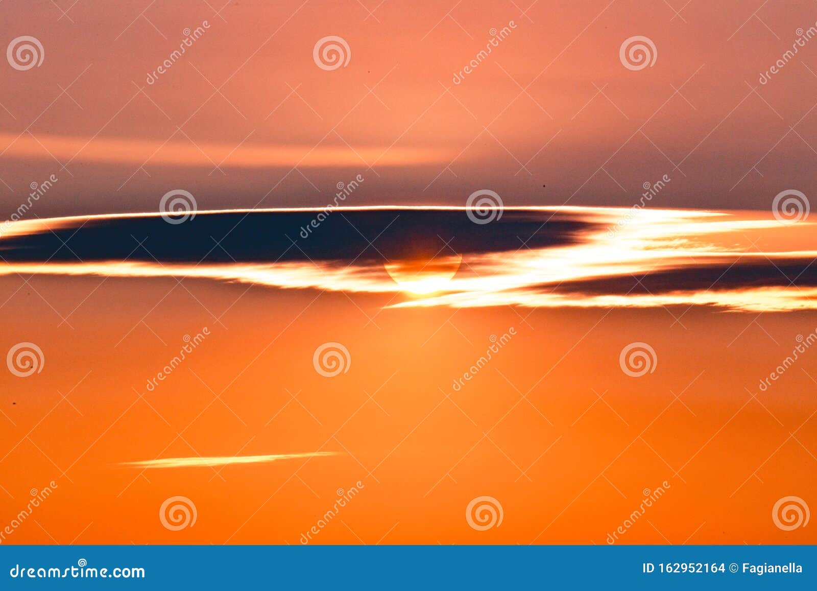 Sun Behind a Cloud: Globe of Fire Perfectly Visibile Stock Photo ...