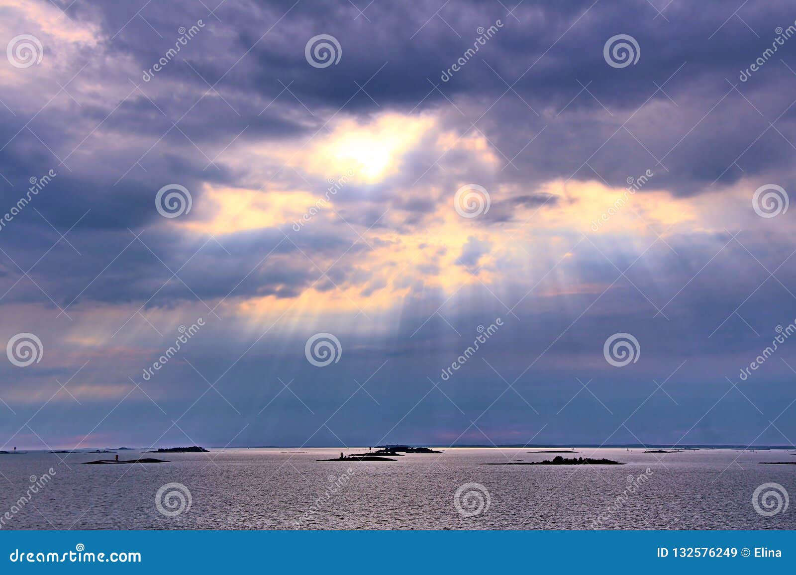 The Sun Behind the Clouds with Rays of Light Shining Down on Sea Stock ...