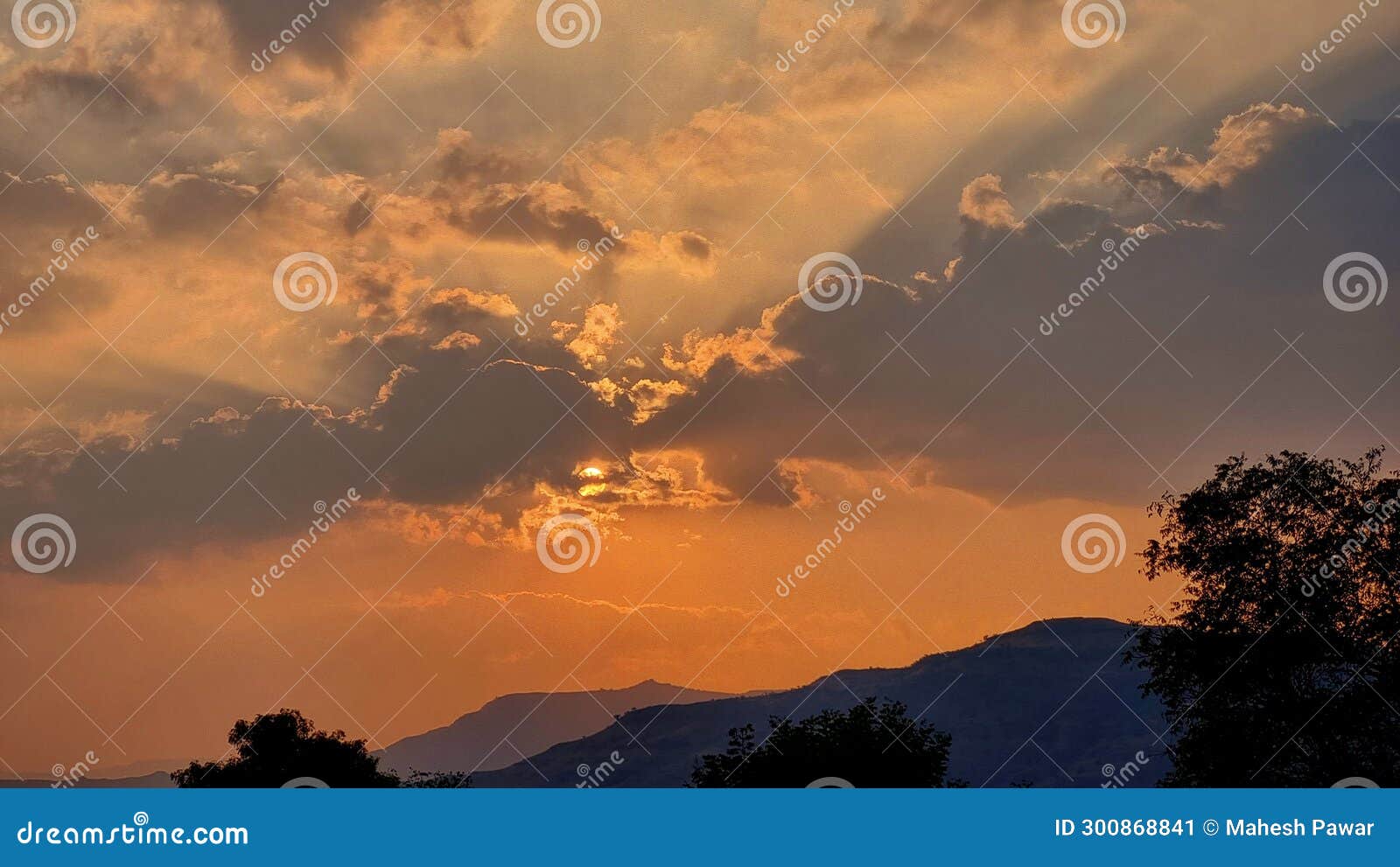 Sun Behind Dramatic Clouds with Sunray Sky Above the Mountain Range ...