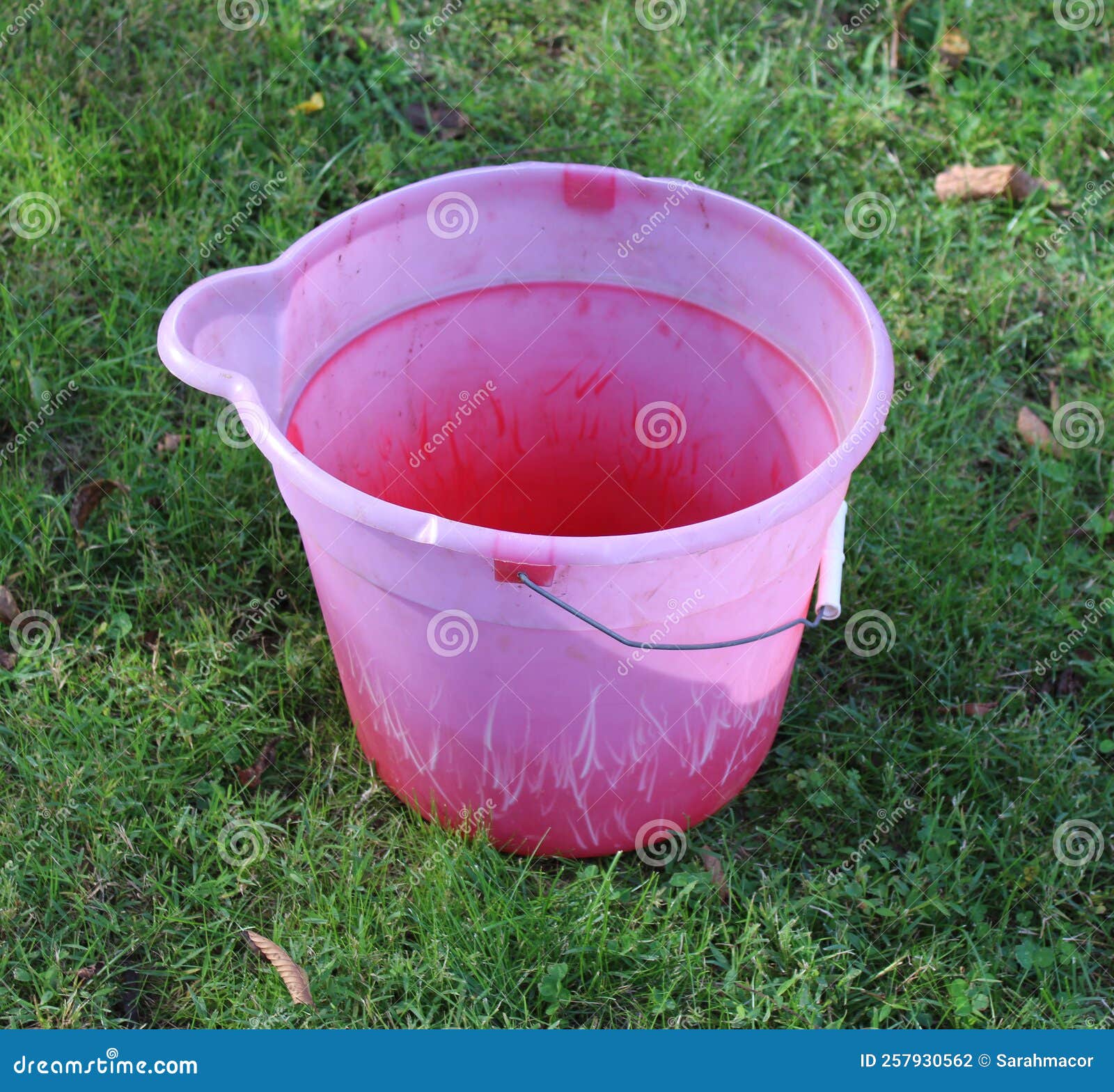 A Sun-Bleached Red Plastic Bucket Stock Photo - Image of worn, faded ...
