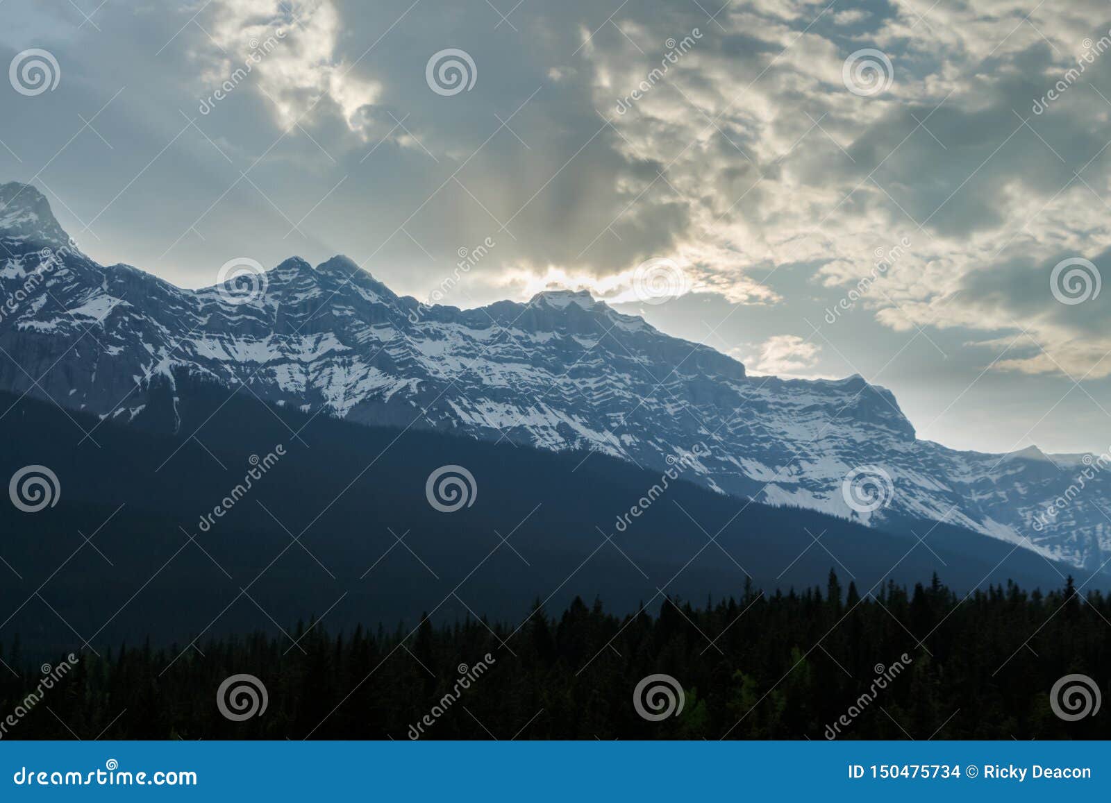 Sun Breaking through Clouds Over Mountain Range Stock Photo - Image of ...