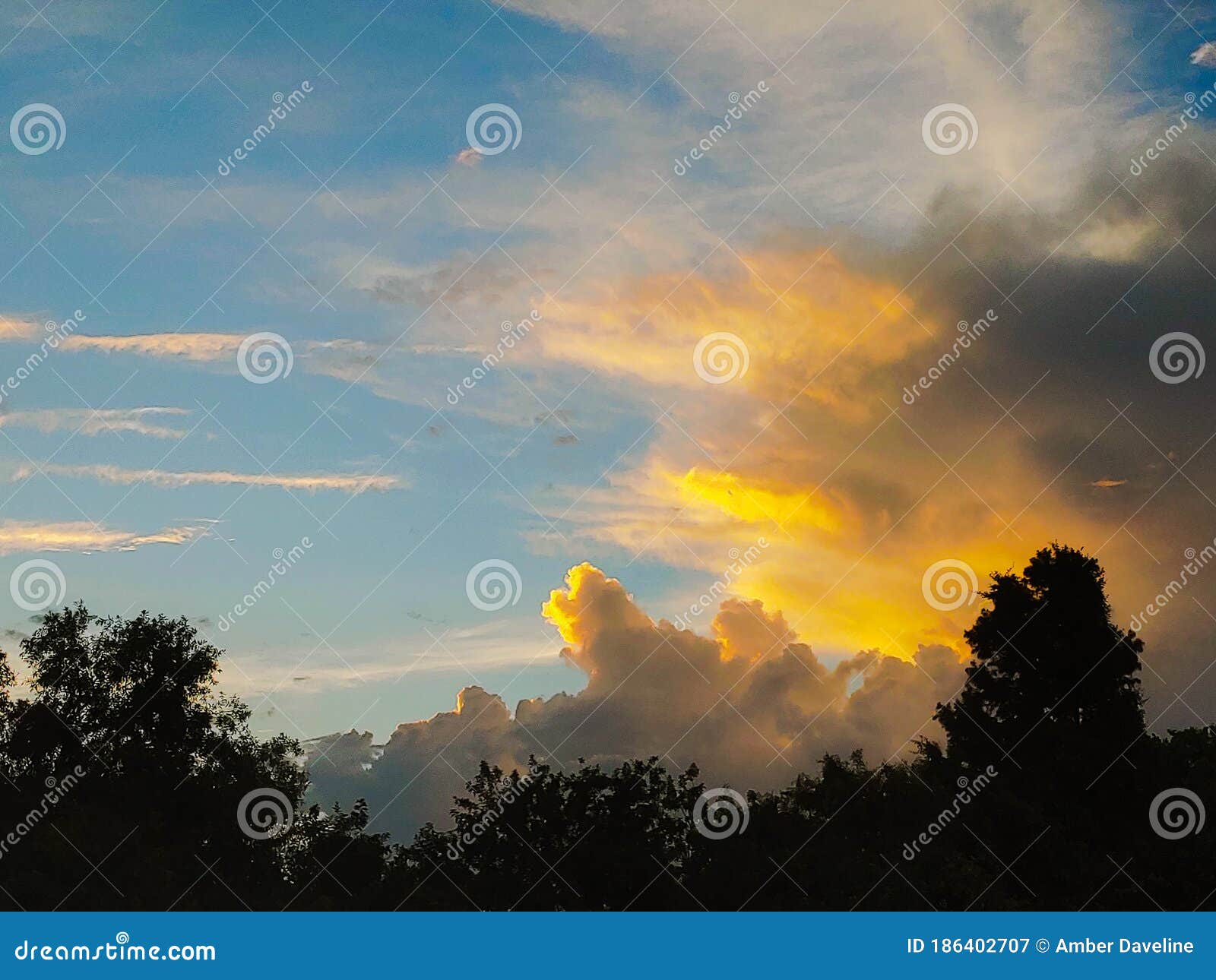 Sun Breaking through the Clouds To Blue Sky. Clouds Over the Trees ...