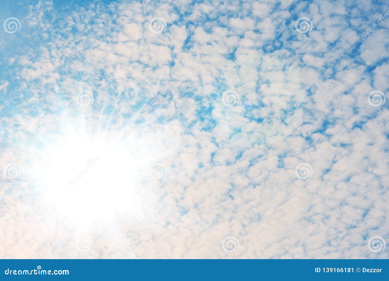 The Sun with Bright Rays in the Blue Sky with White Light Clouds Stock ...