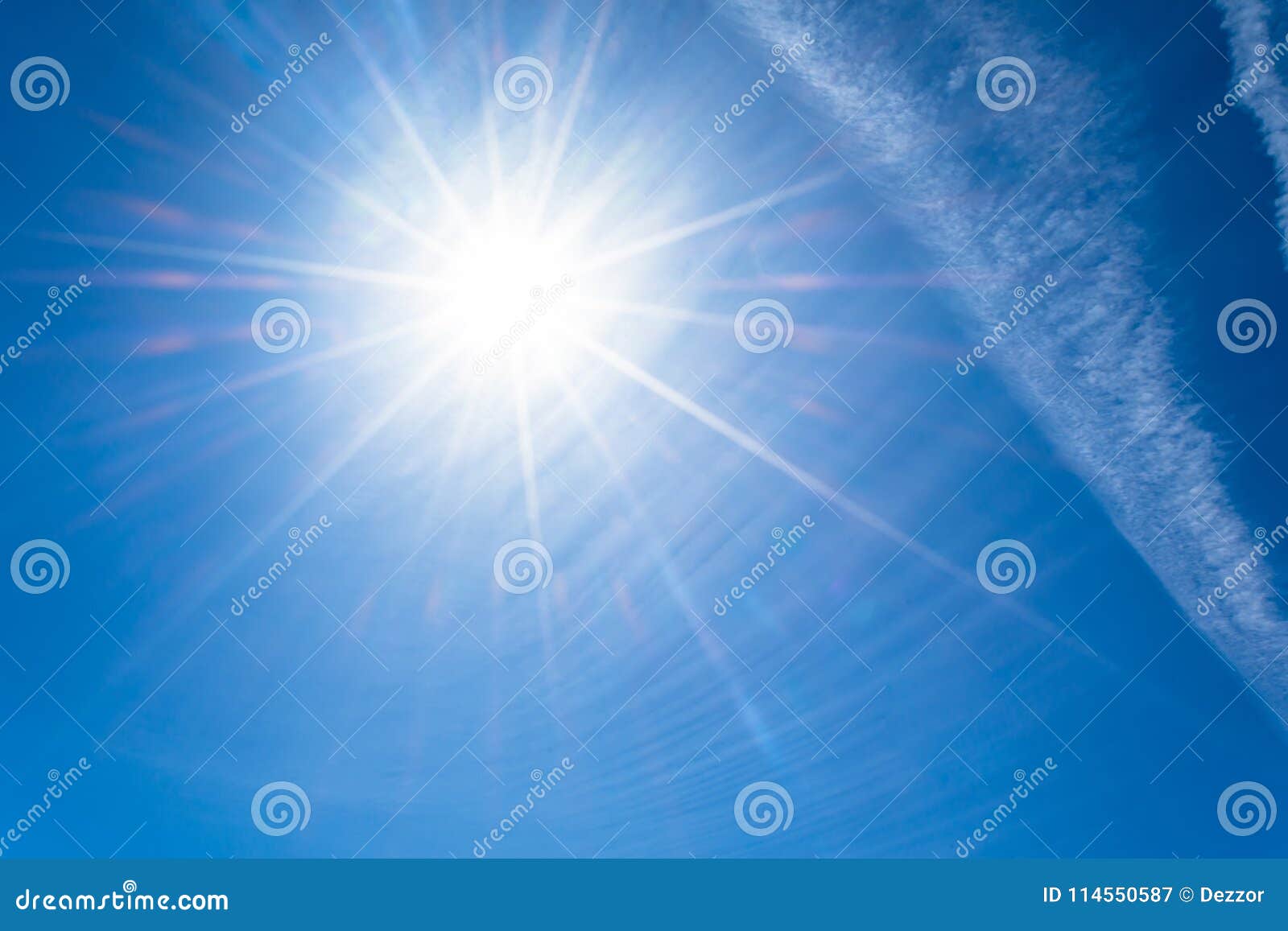 The Sun with Bright Rays in the Blue Sky with White Light Contrail ...