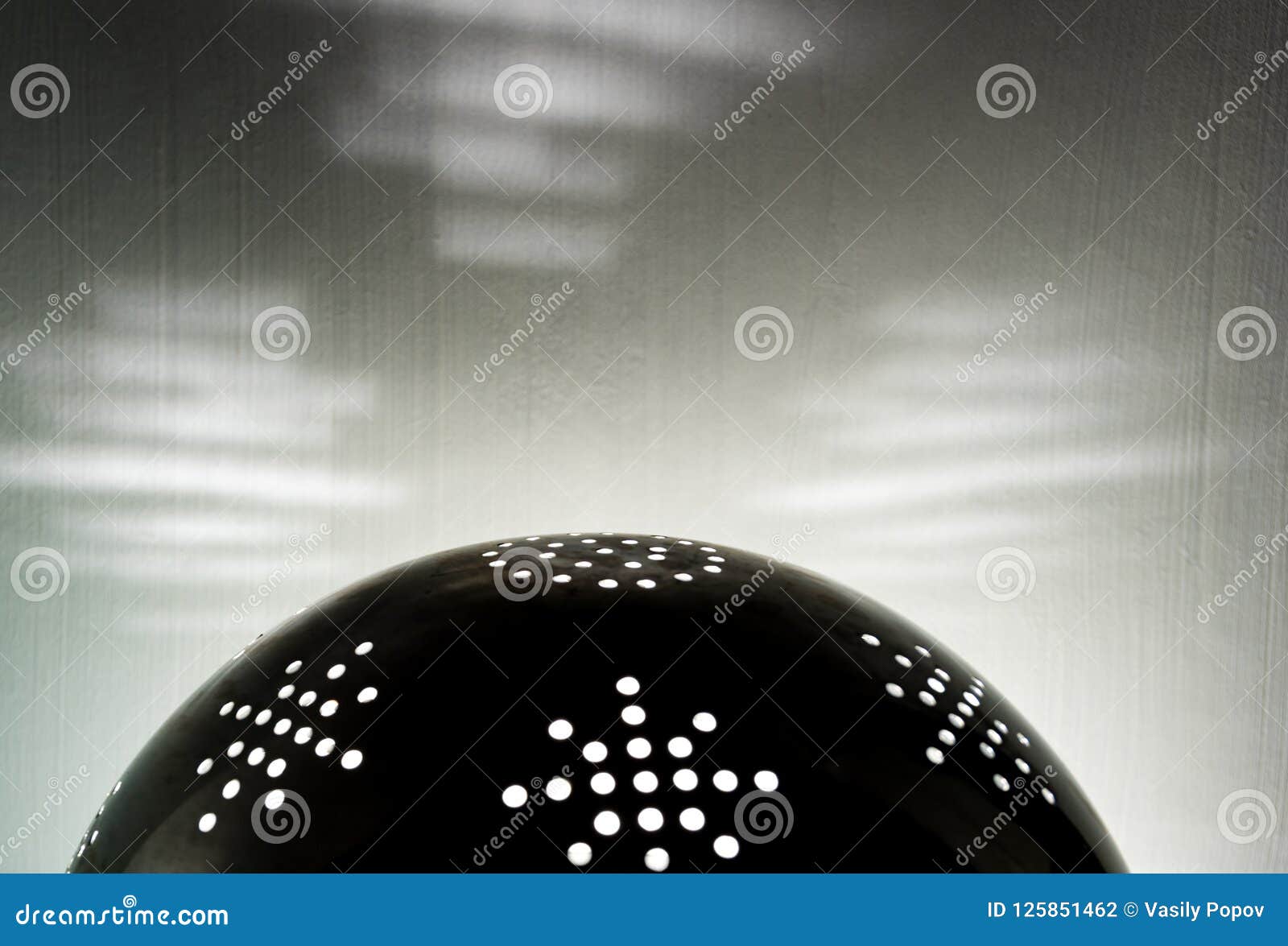 The Sun in a Colander. Rays of Light through the Holes Stock Photo ...